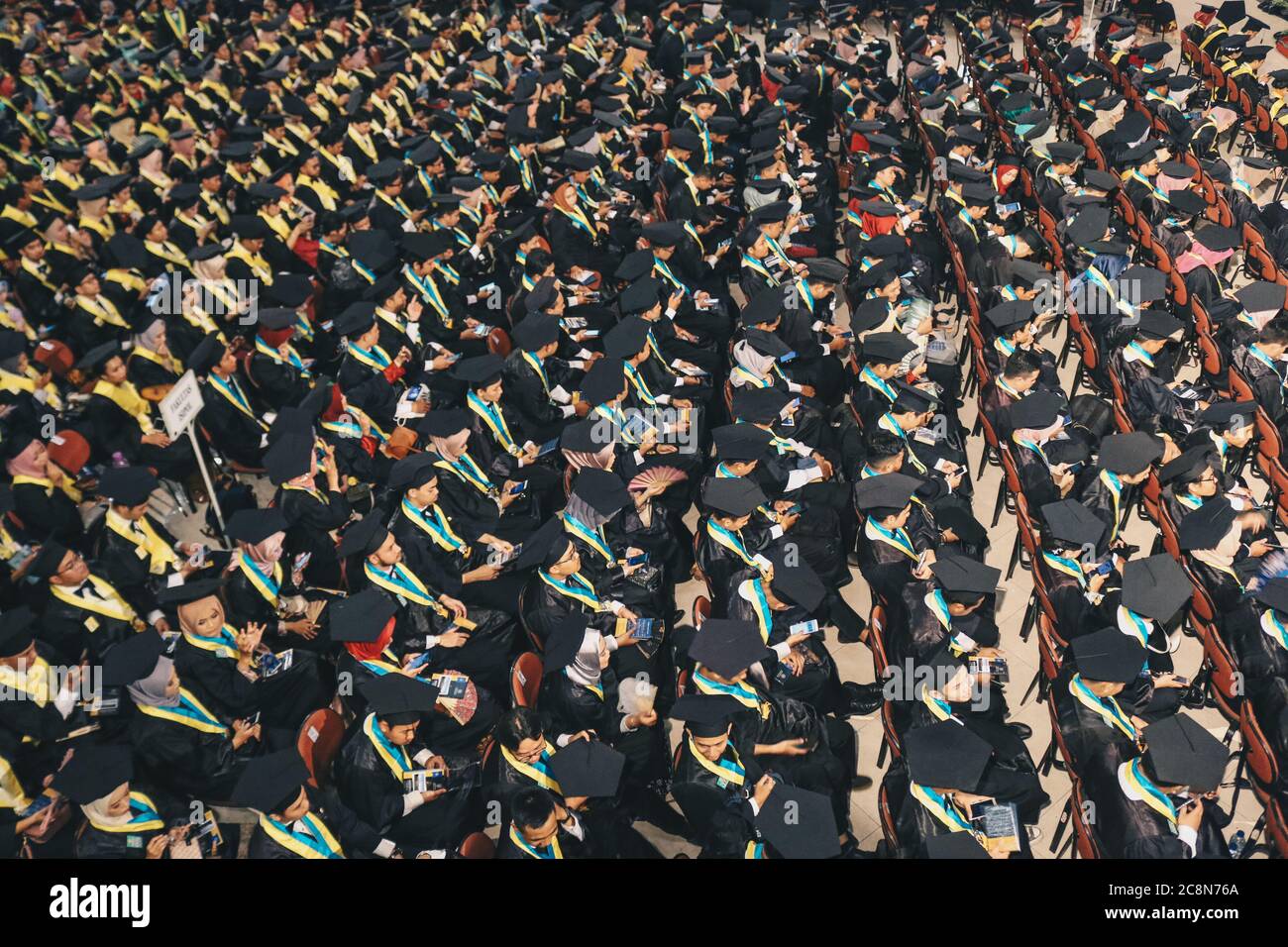 Top view of group of university graduates in black gowns lines up for ...