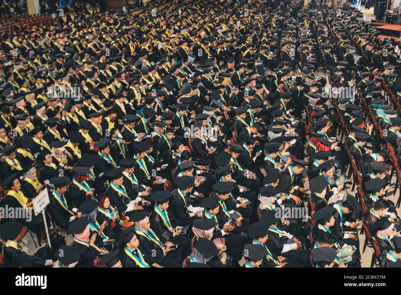 Top view of group of university graduates in black gowns lines up for ...