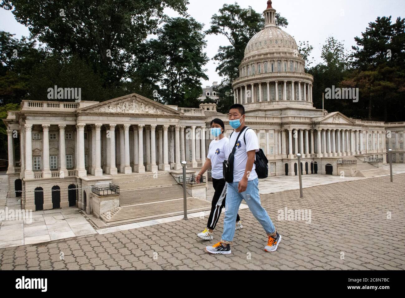 Beijing, China. 26th July, 2020. Tourist walks in front of maquette of ...