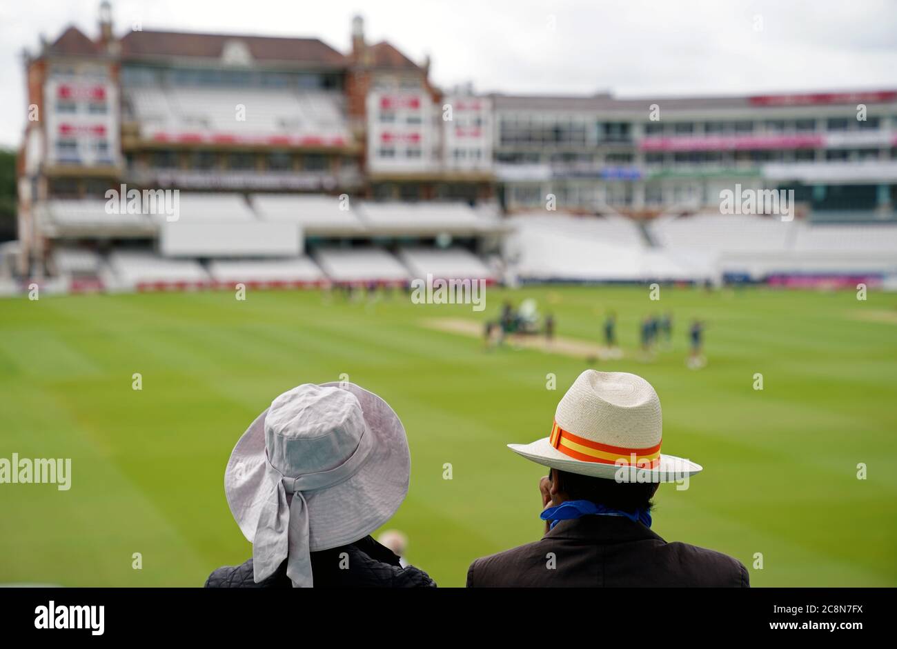Spectators take their seats as players warm up before the friendly ...