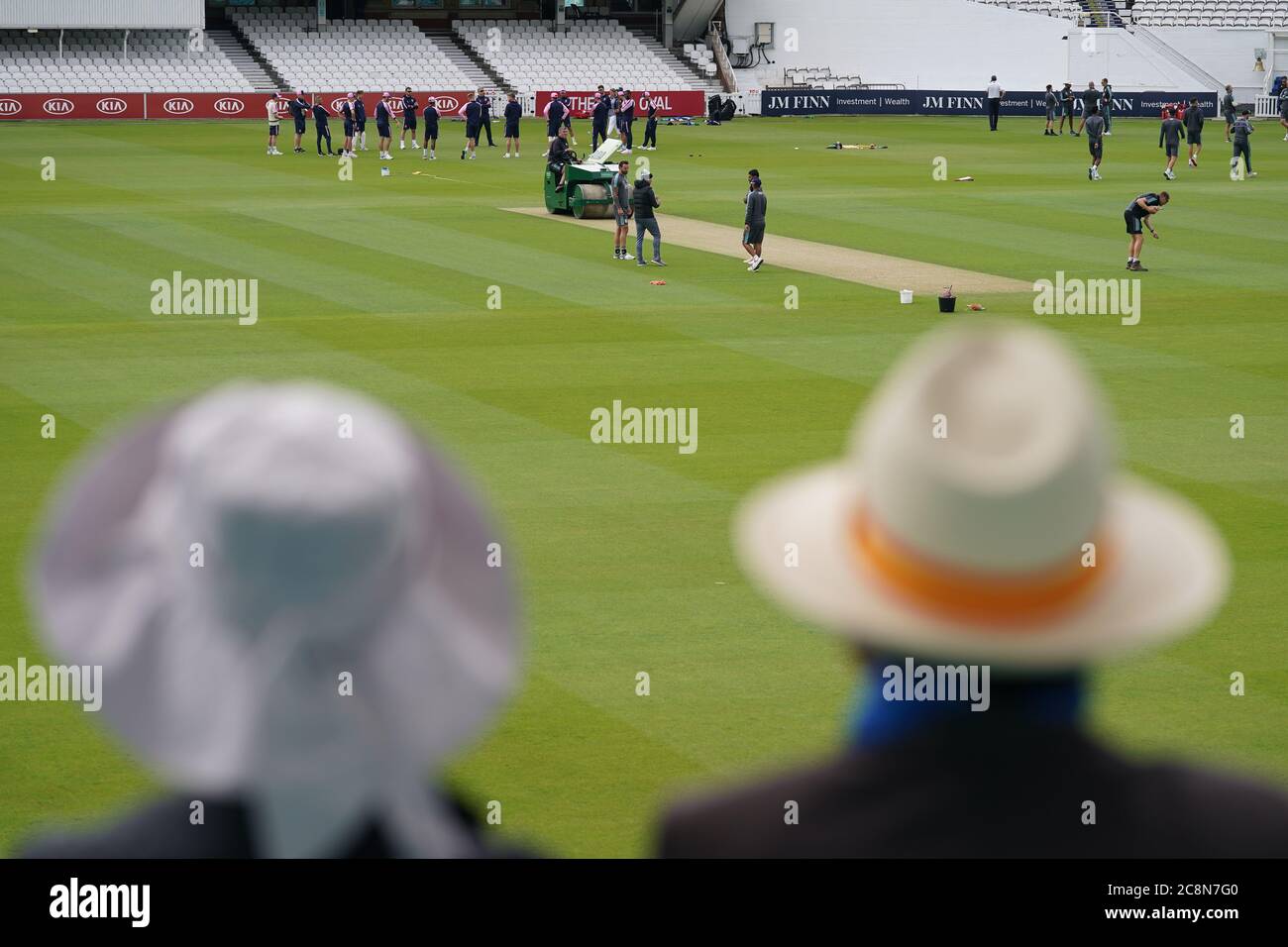 Spectators their seats as players warm up before the friendly match at ...