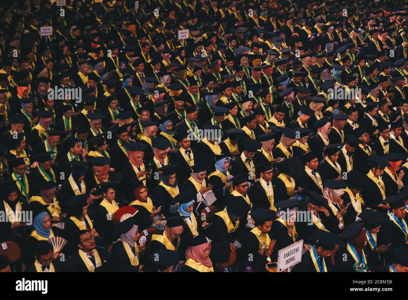Top view of group of university graduates in black gowns lines up for ...