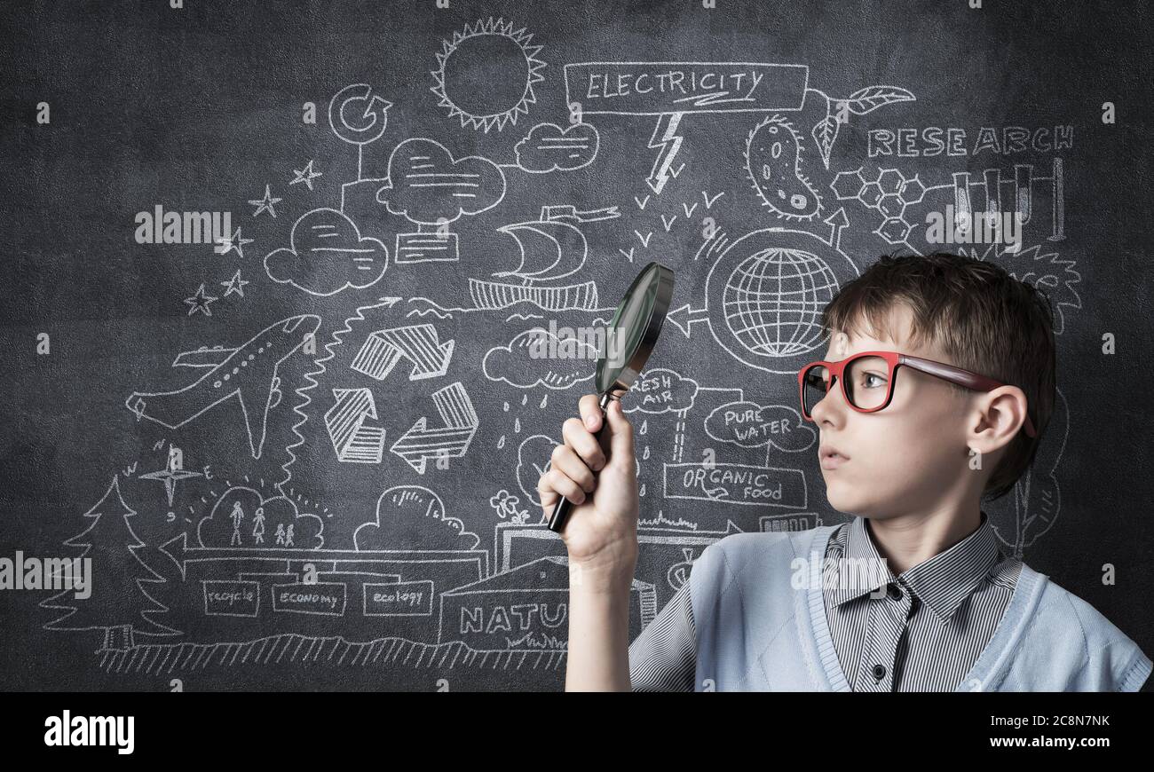 Curious school boy with magnifier Stock Photo - Alamy