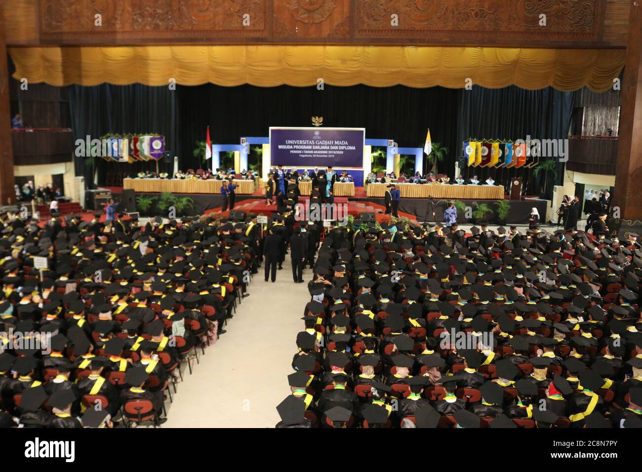 Top view of group of university graduates in black gowns lines up for ...