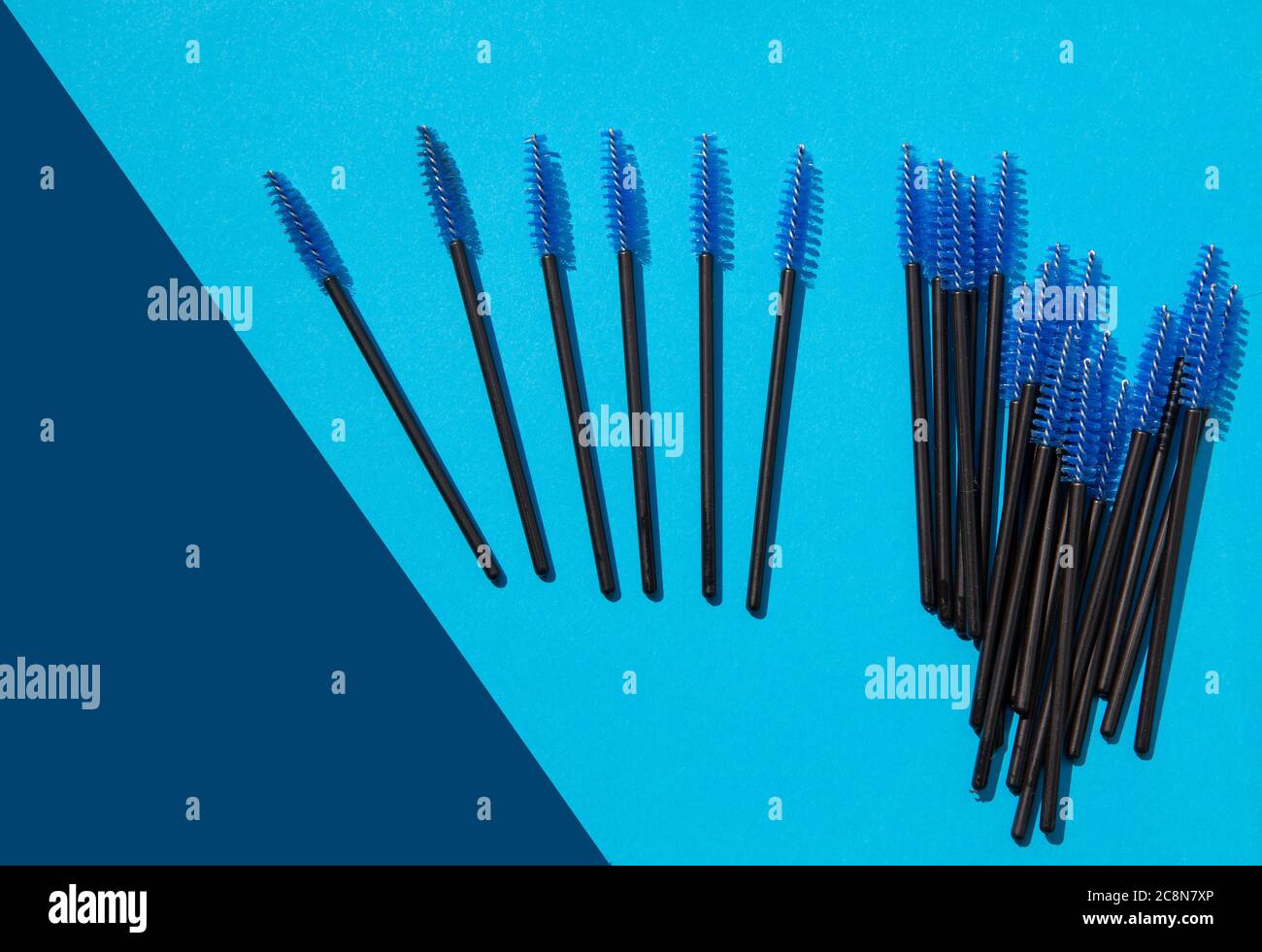 blue makeup brushes, combs for eyelashes and eyebrows on a blue ...