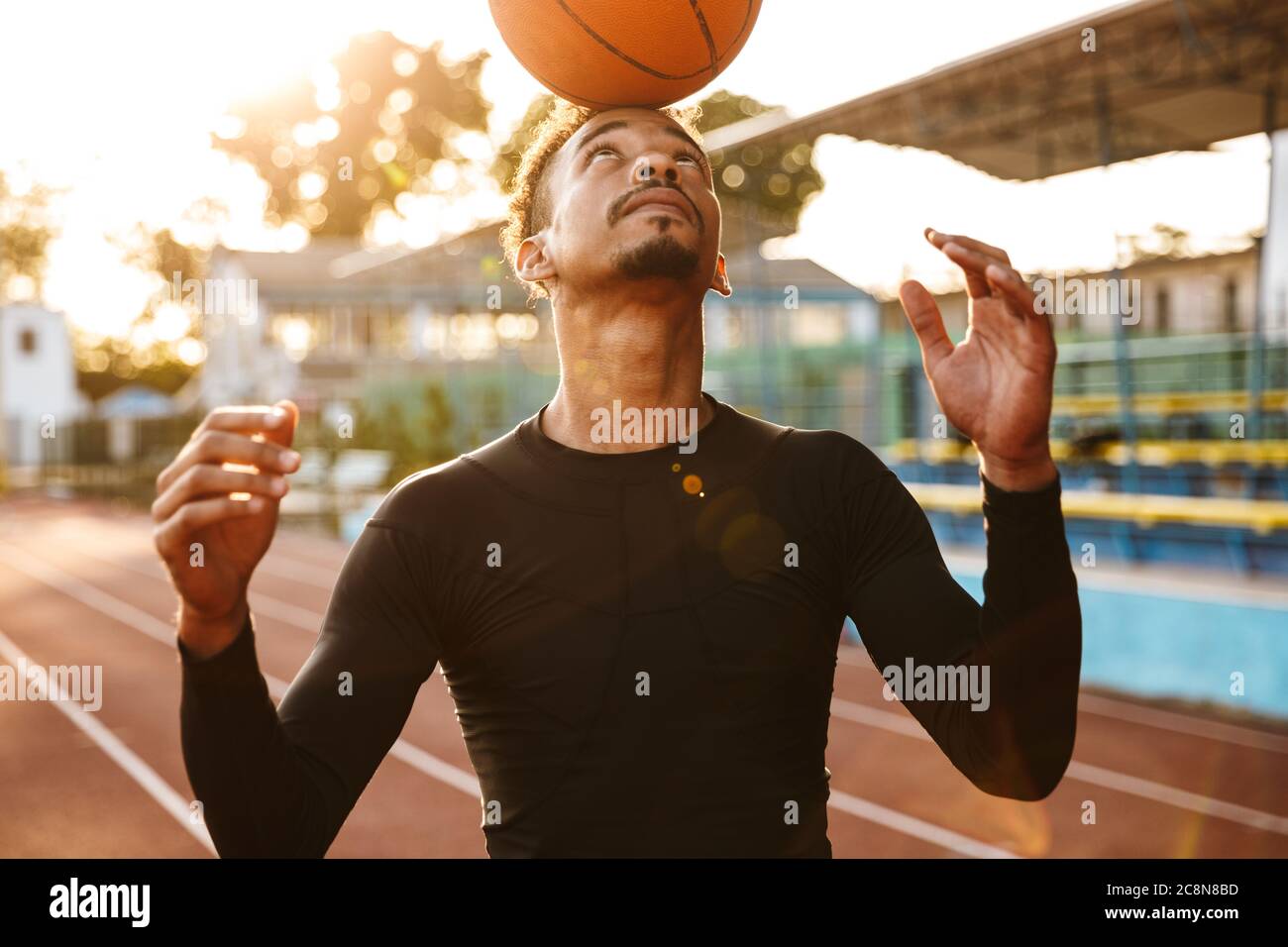 Image of a strong african handsome young sports man at stadium outdoors ...