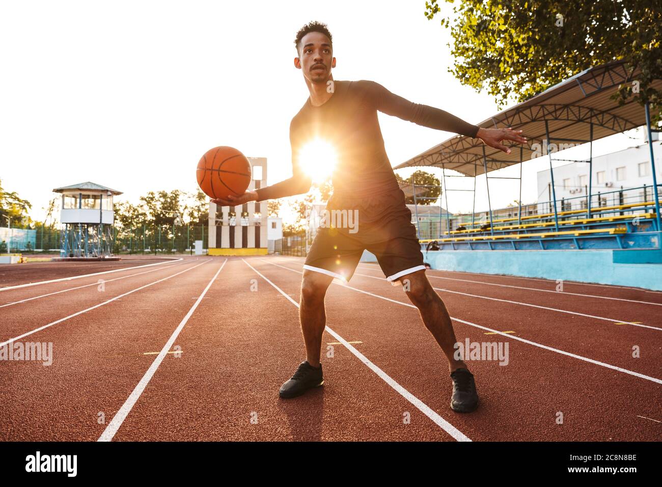 Image of a strong african handsome young sports man at stadium outdoors ...