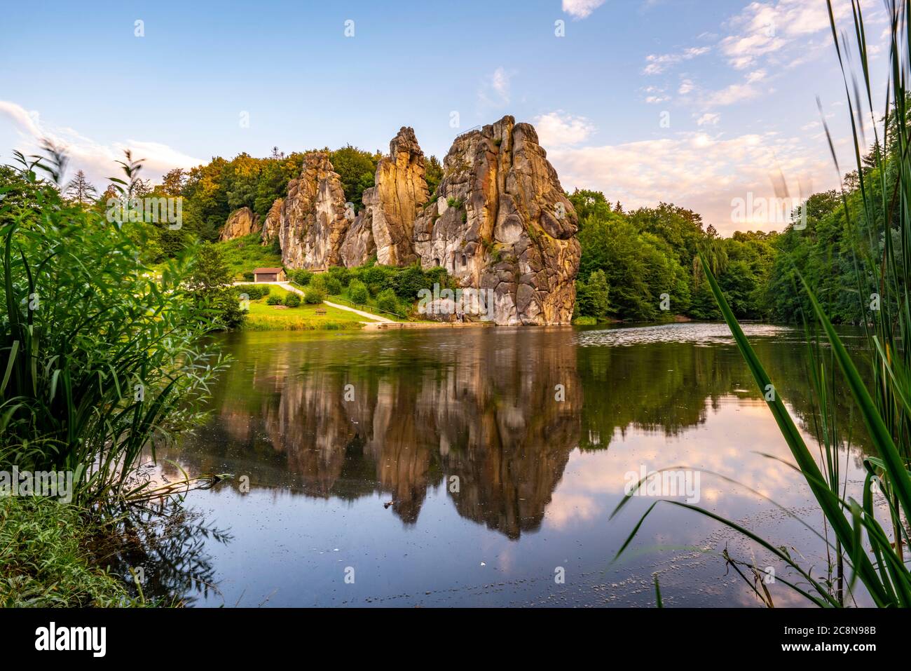 The Externsteine, a sandstone rock formation, Wiembecketeich pond, in ...