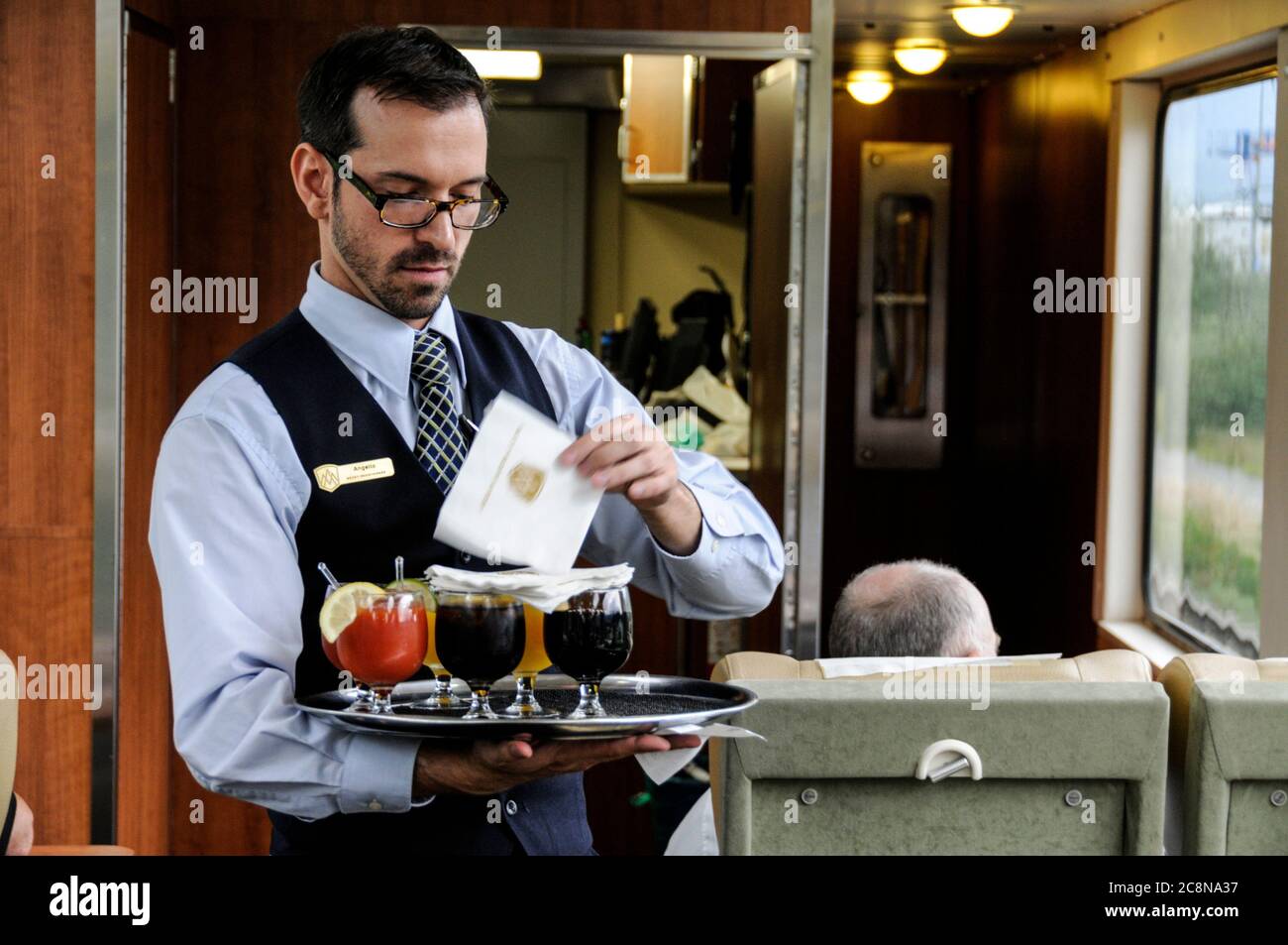 A restaurant-car attendant serving drinks on board the Rocky ...