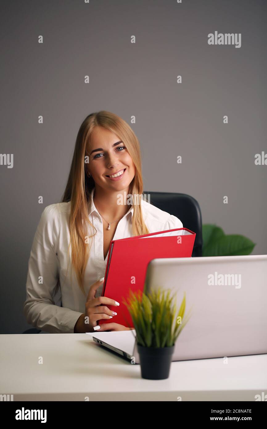 Focused woman working at her computer. Background for office startup ...