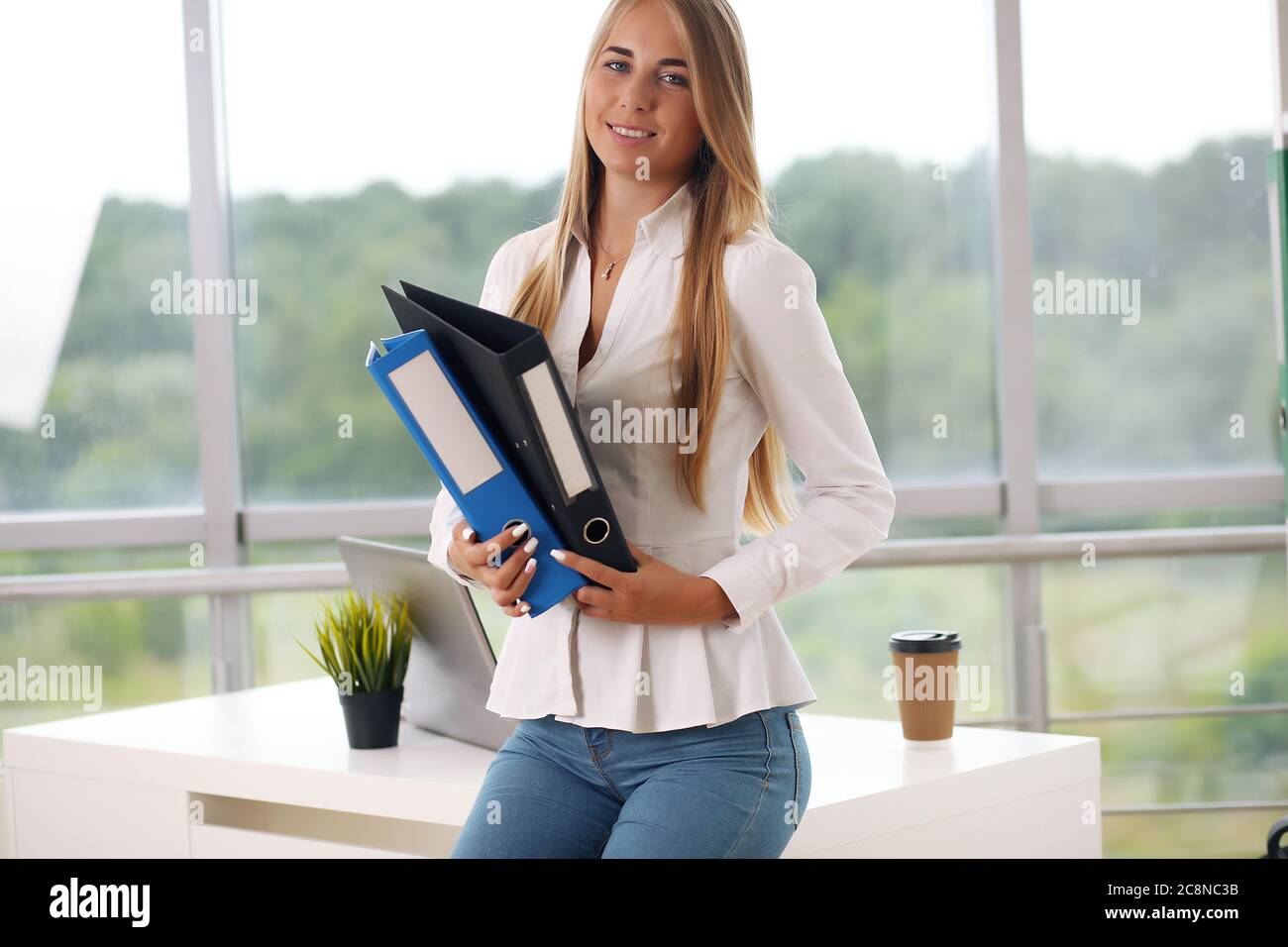business woman smiling pretty young standing at workplace Stock Photo ...