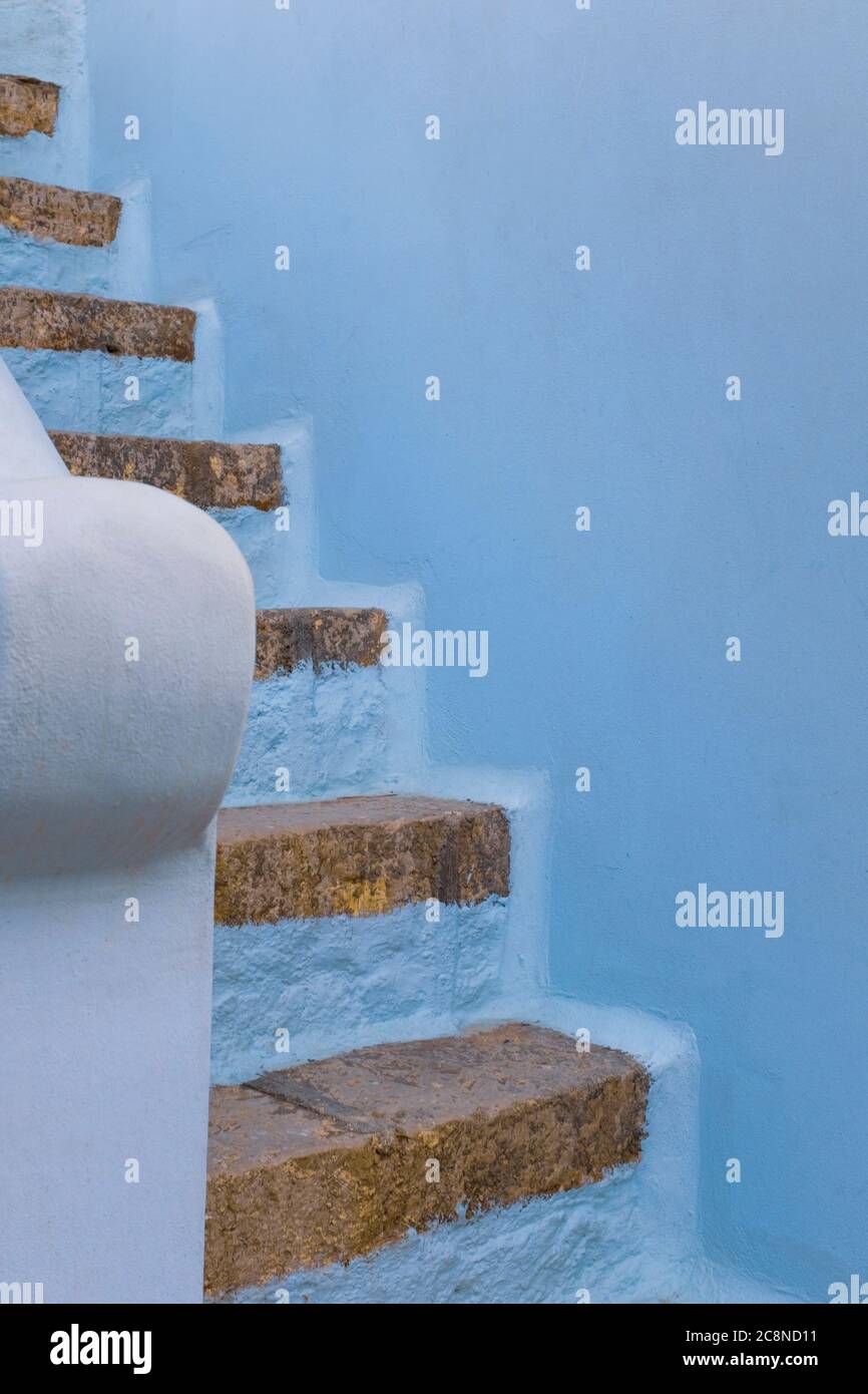 Stone steps next to a blue painted wall in Greece Stock Photo - Alamy