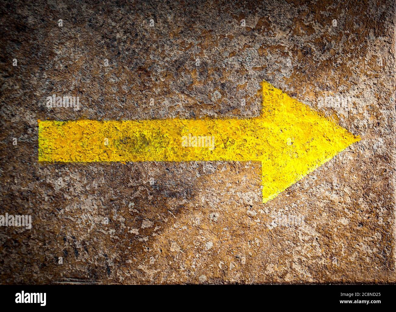 Arrow sign on stone closeup, antique pavement texture Stock Photo - Alamy