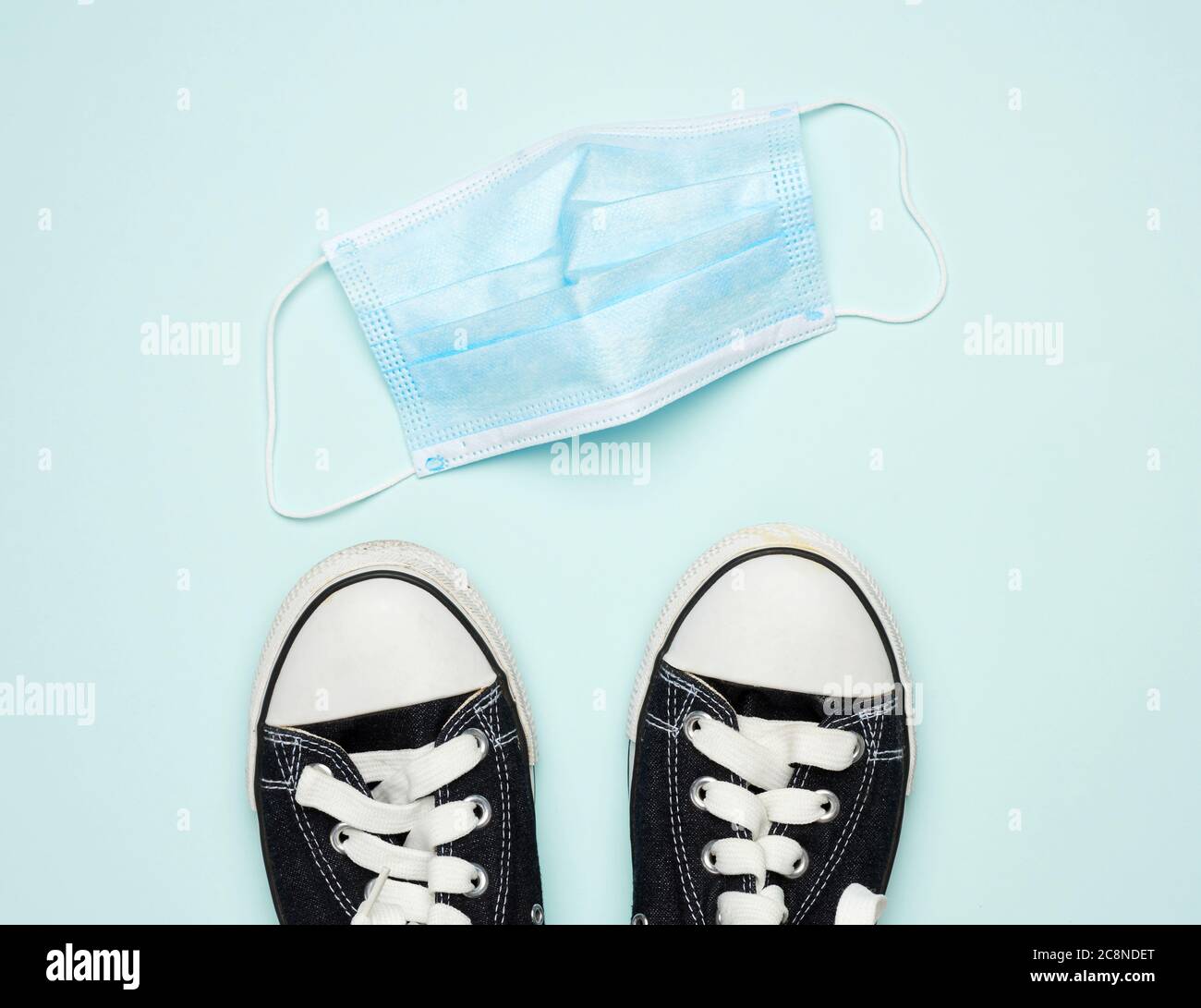 mask and blue sneakers on a blue background, safe walks during a viral ...
