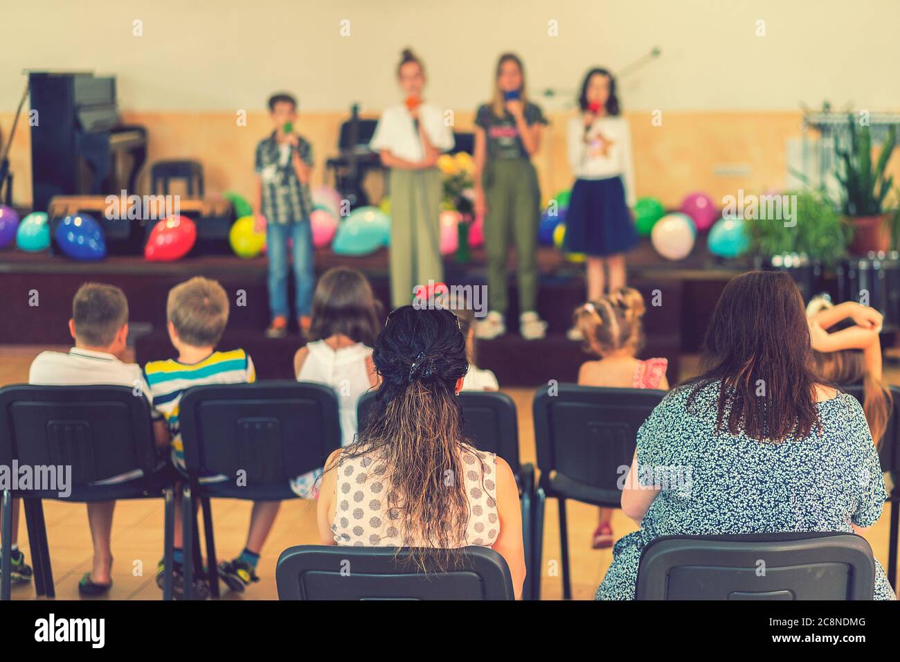 Children's holiday in elementary School. Children on stage perform in ...