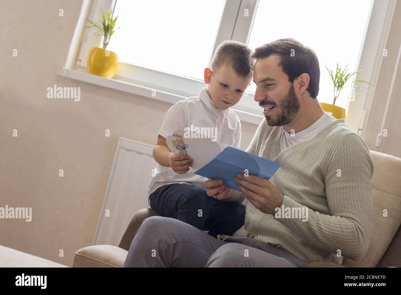 Kid giving a greeting card to his father Stock Photo - Alamy