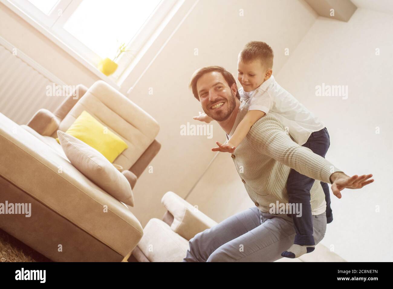 Caucasian father playing with his chid at home Stock Photo - Alamy
