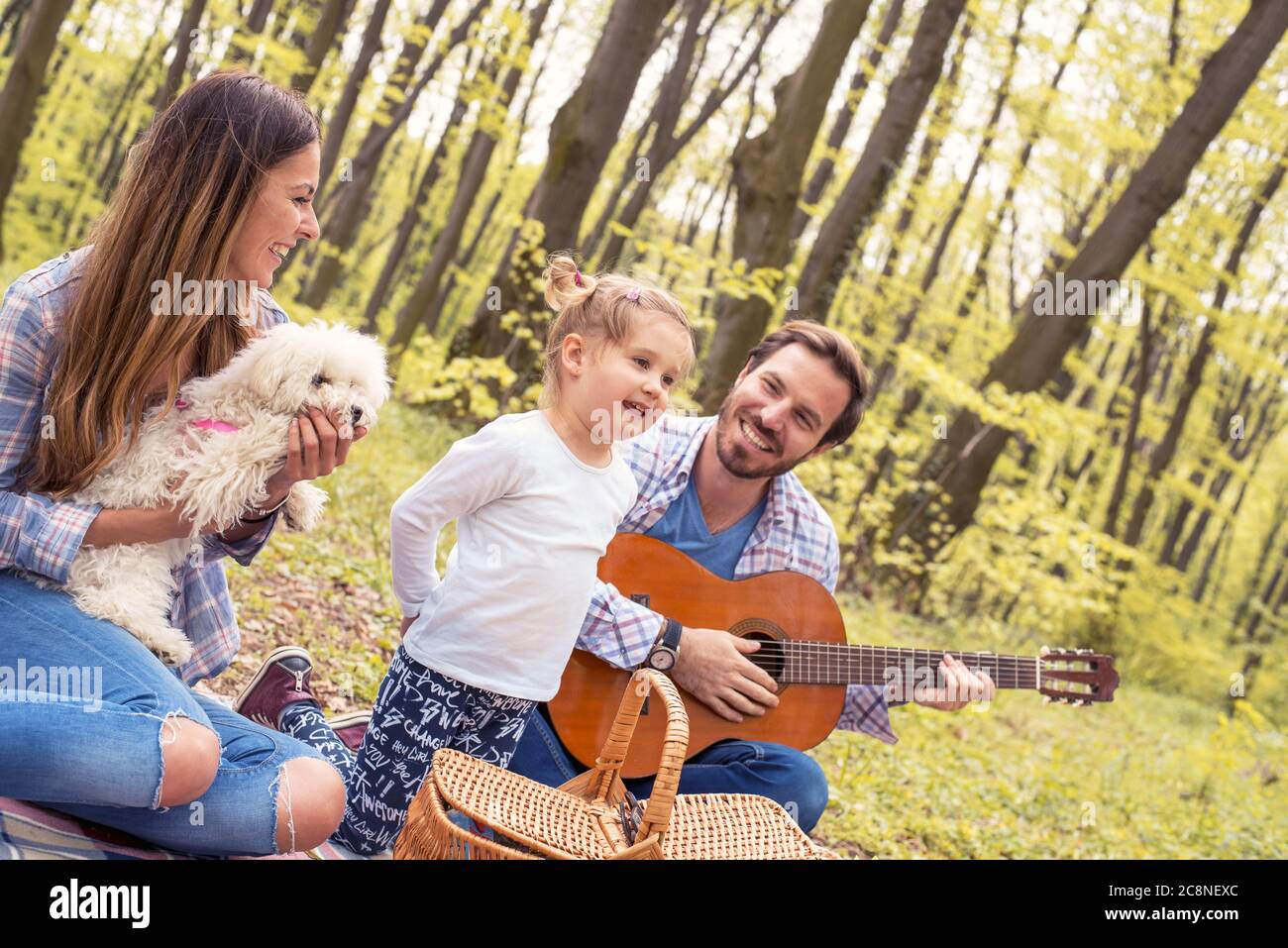 Shallow focus shot of a happy family having a picnic in a forest Stock ...
