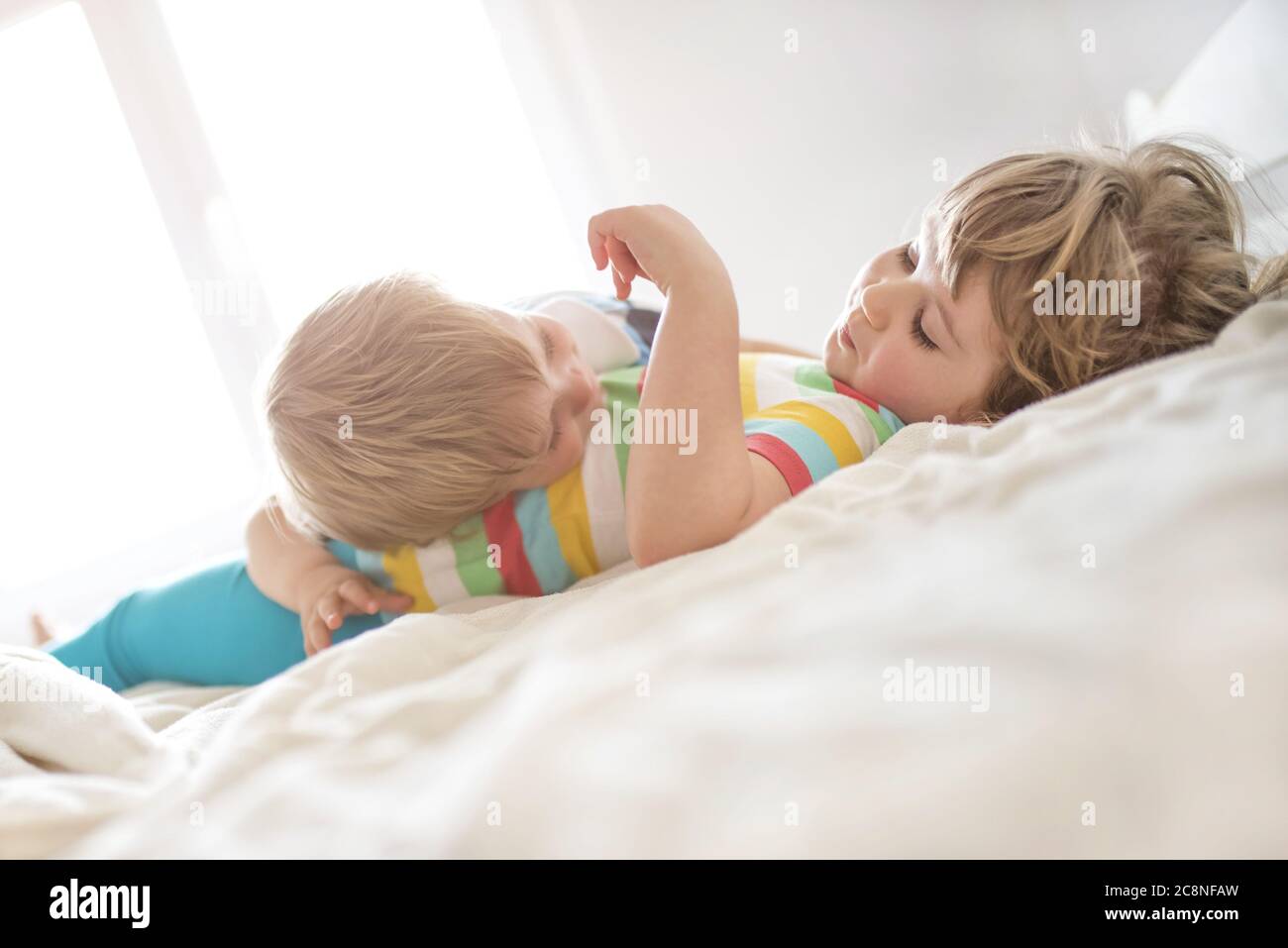 Shallow focus shot of Caucasian brother and sister cuddling together Stock Photo - Alamy