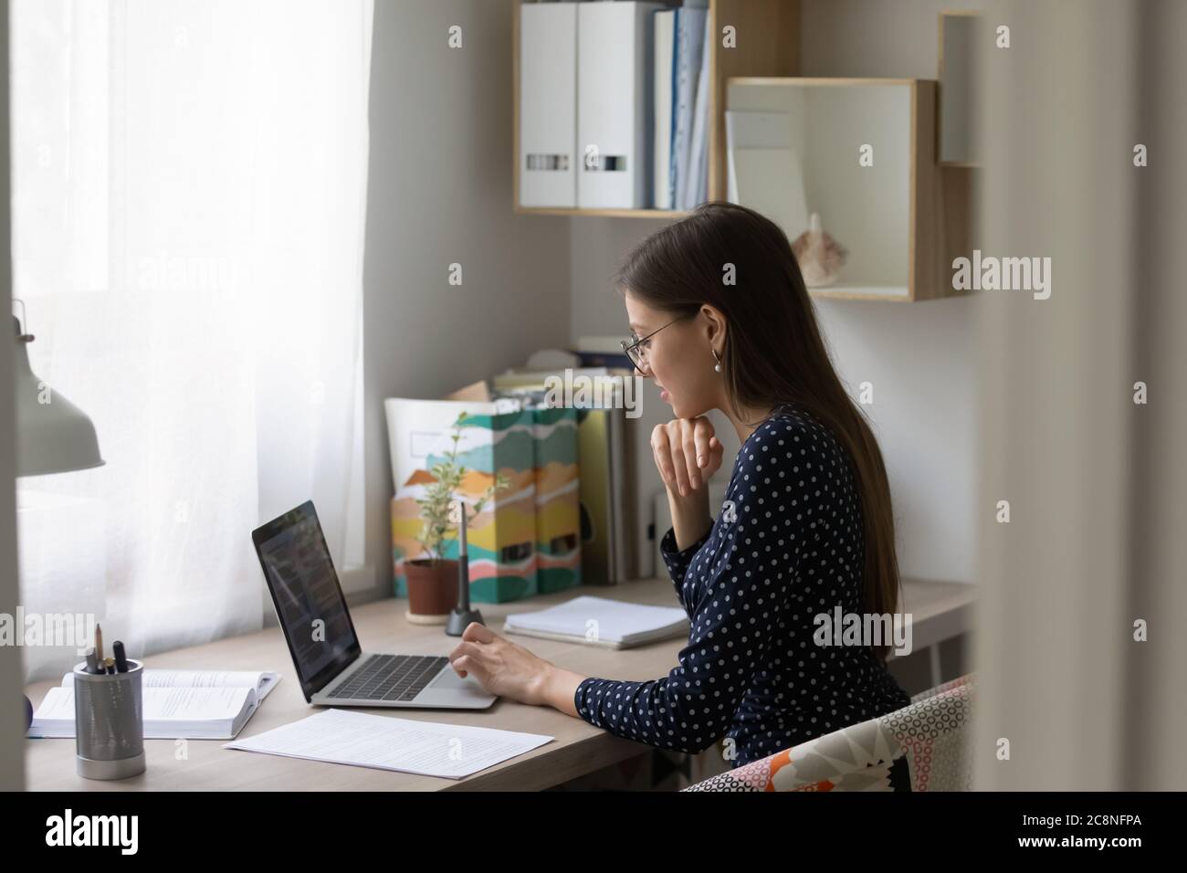 Young girl sit at desk study on laptop Stock Photo - Alamy