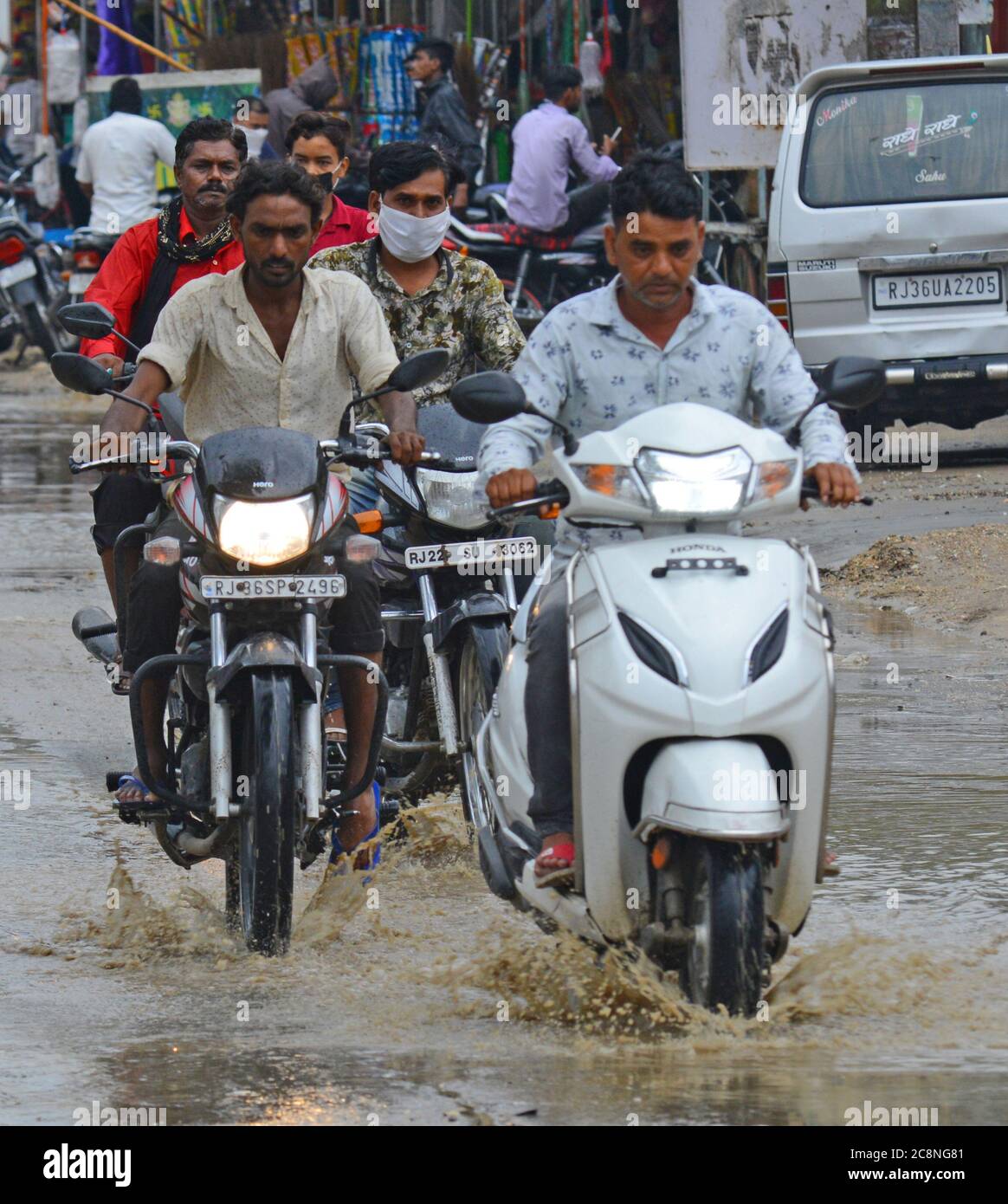 Beawar, Rajasthan, India, July 25, 2020: Vehicles ply on a waterlogged ...