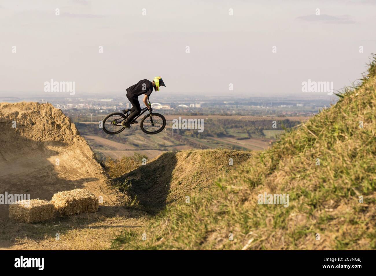 Biker jumping and flying over a hill Stock Photo - Alamy