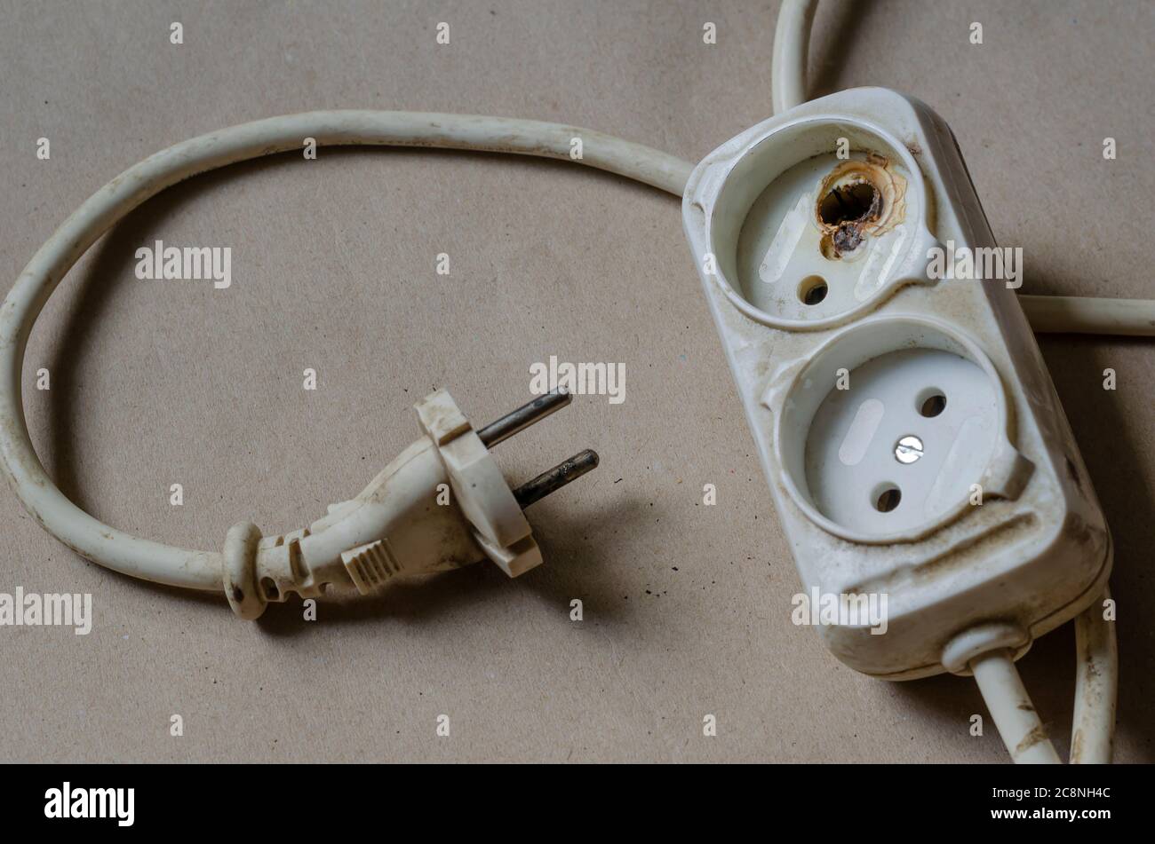 Electrical plug condition ,outlet after shock on brown background ...