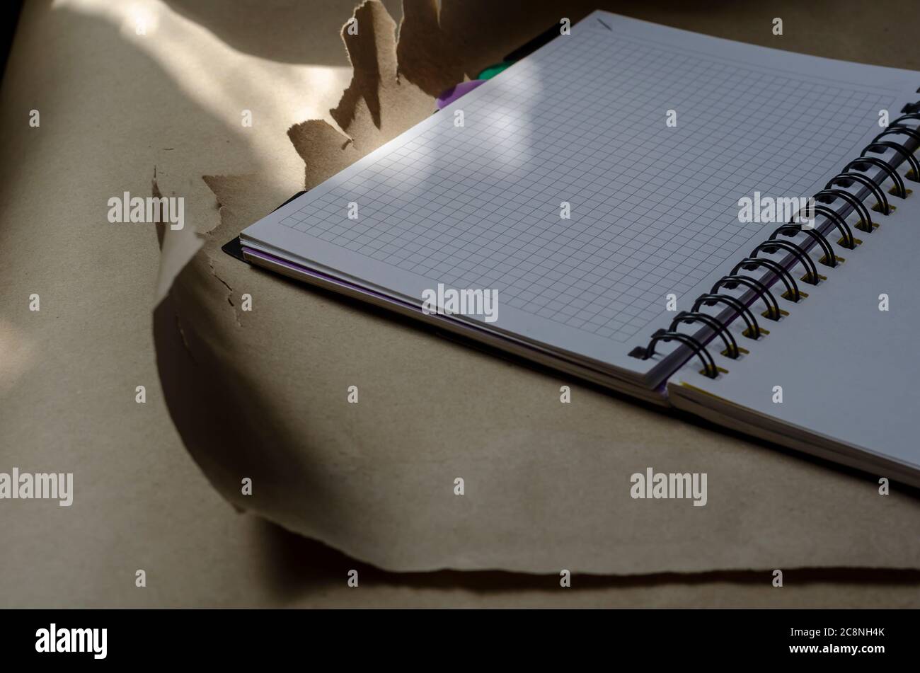 Open spring-bound notebook in sunlight. New diary with blank pages on ...