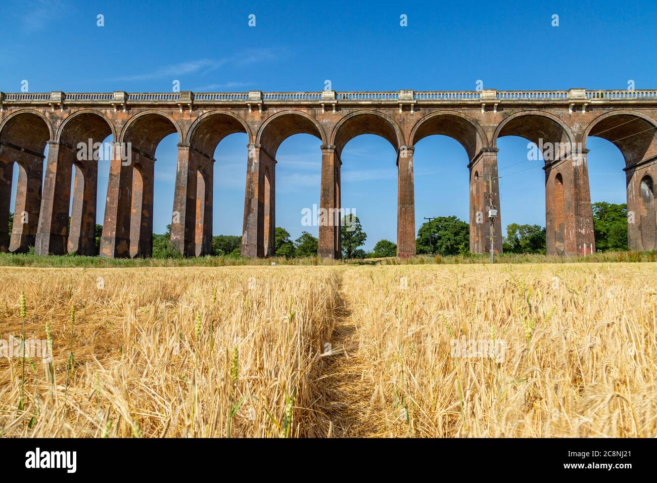 A pathway through a field leading to the Ouse Valley Viaduct, in Sussex ...