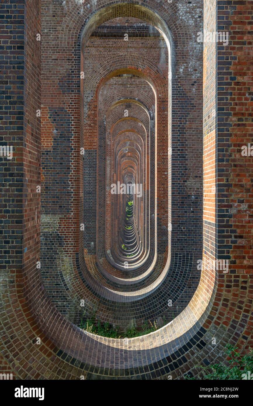 Looking through the architectural arches of the Ouse Valley Viaduct in ...