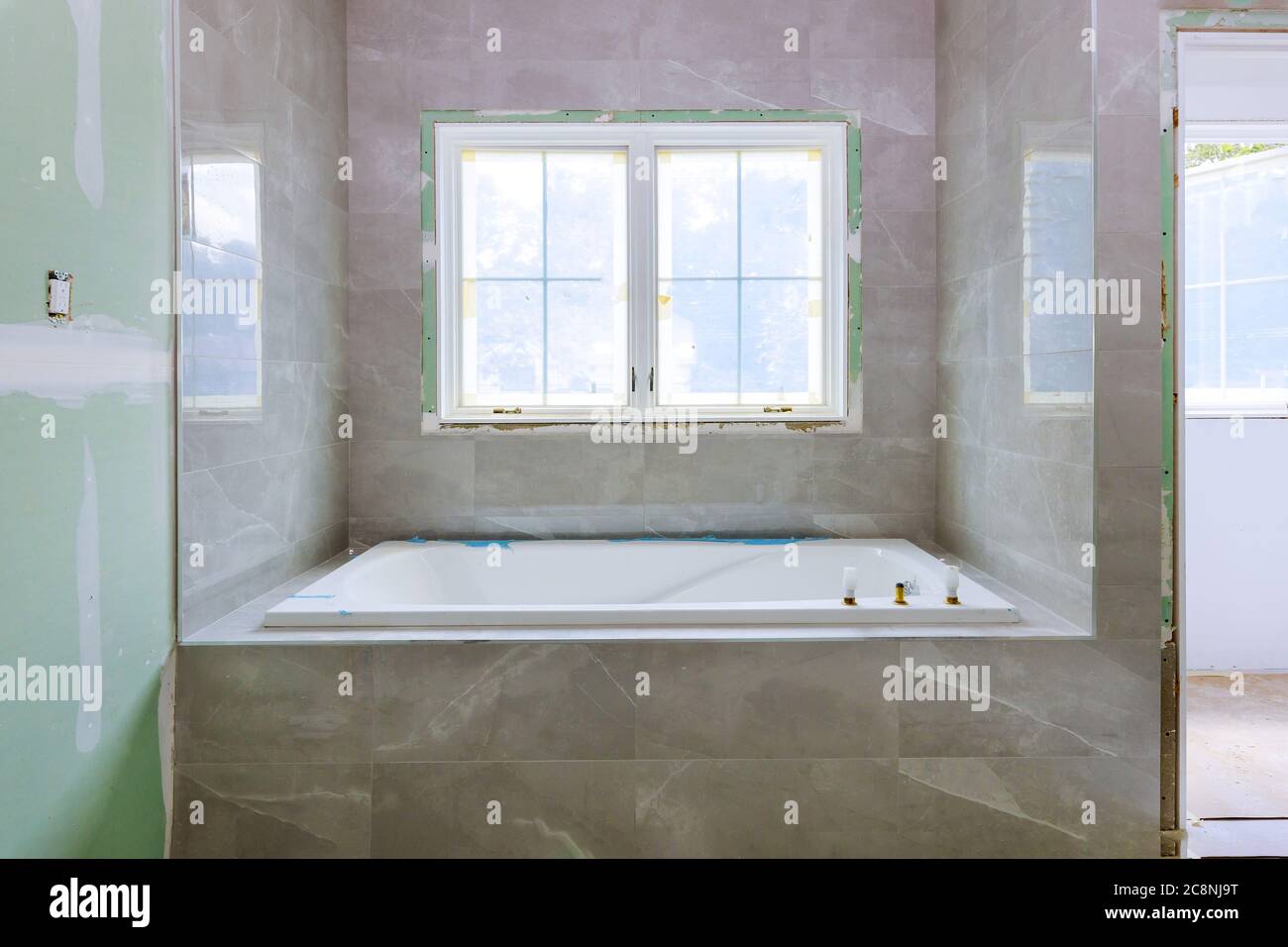 Home construction bathtub walls tiled after installing remodeling ...