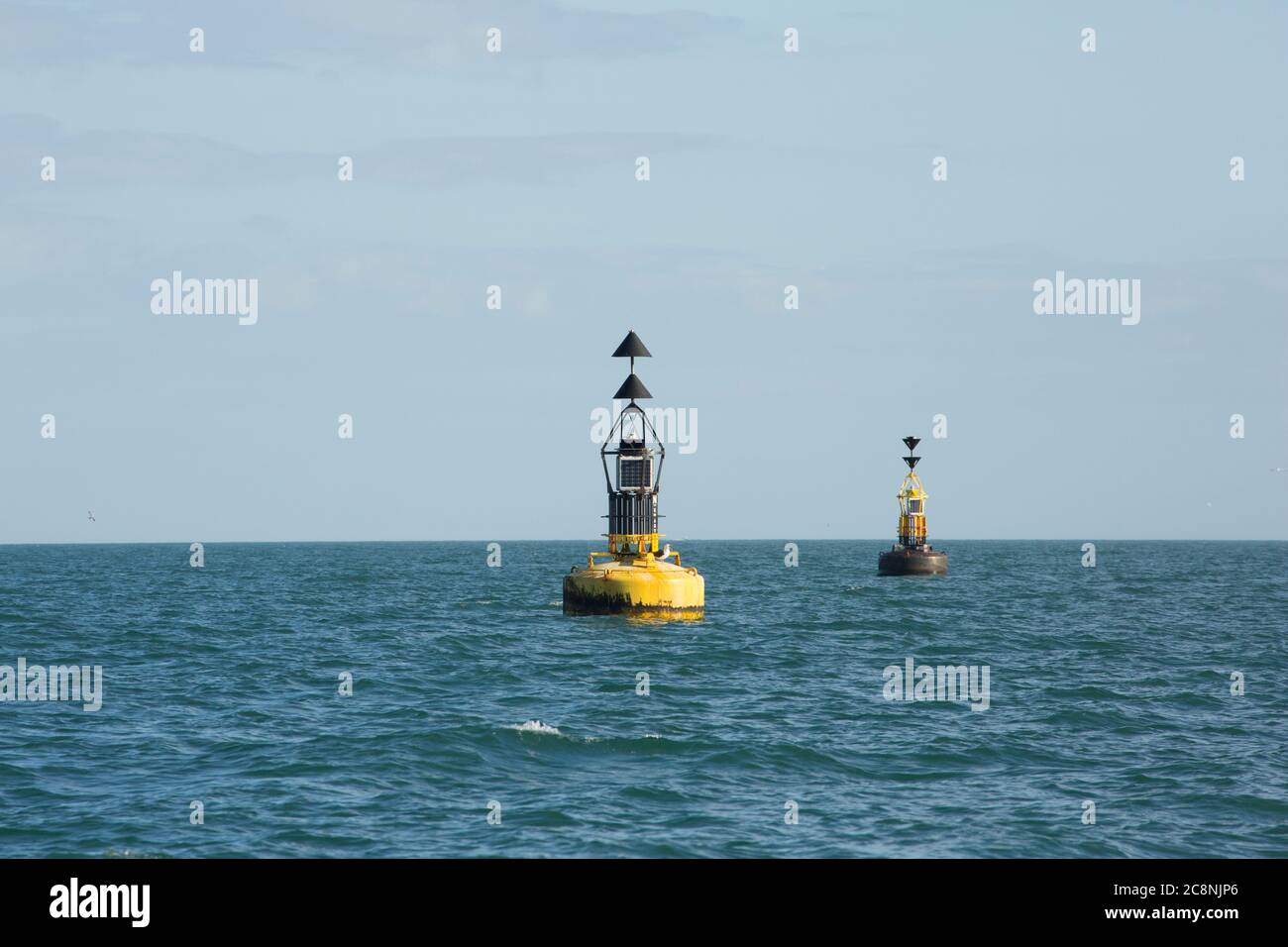 Left to right: A north cardinal buoy and south cardinal buoy off the ...