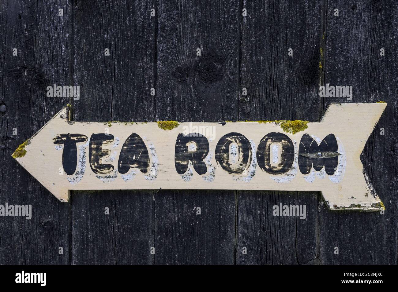 A wooden tea room sign on a black background Stock Photo - Alamy
