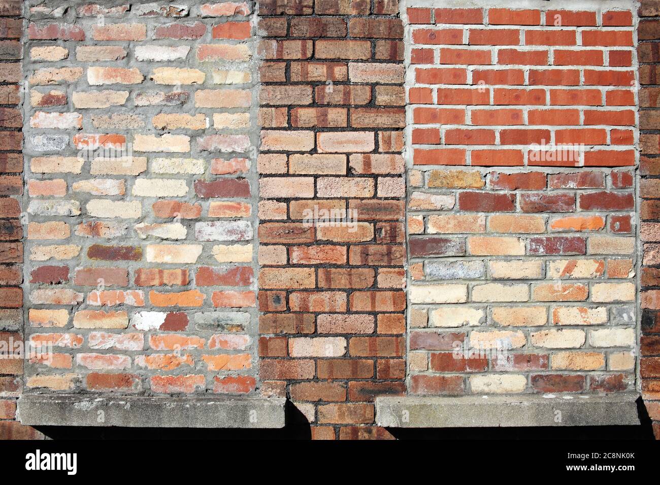 Old large weathered distressed red brick wall with bricked up windows ...