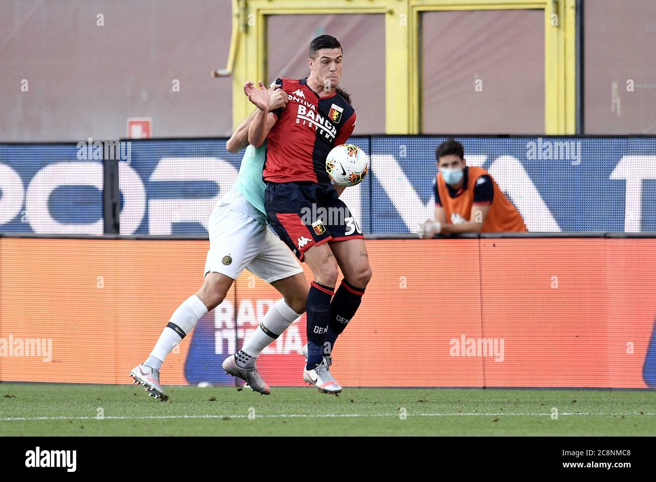 Andrea Favilli of Genoa CFC in action against Andrea Ranocchia of FC ...