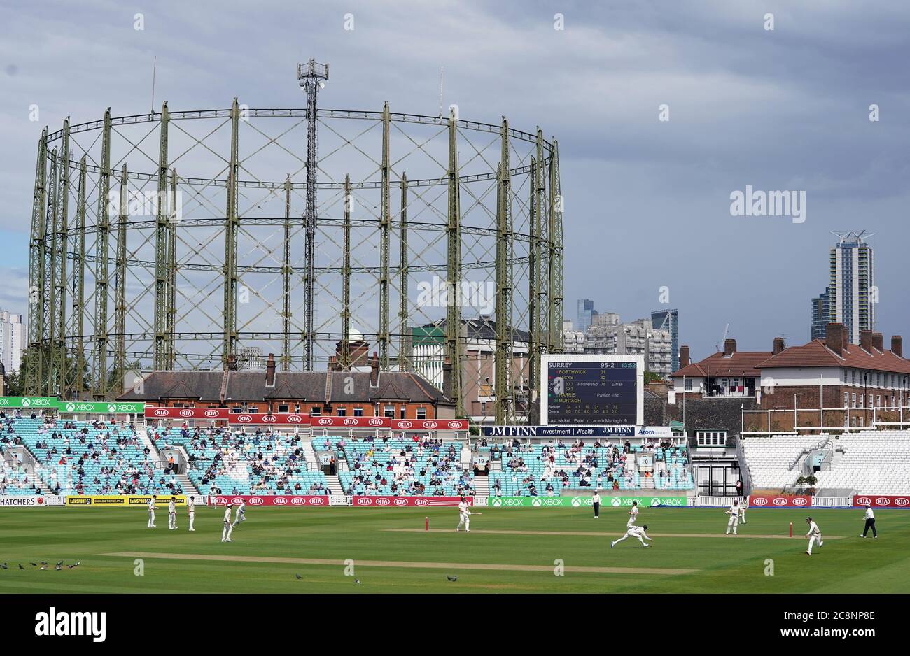 Spectators watch the action in front of the Oval Gasholders during the ...