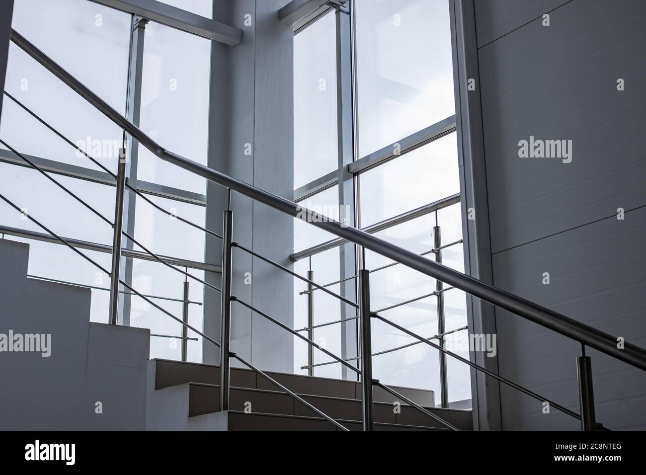 Staircase with metal railings by the window indoor Stock Photo - Alamy