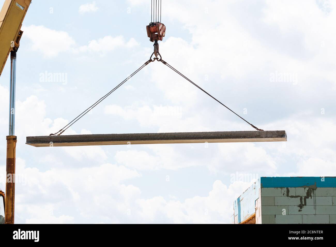Builder worker installing concrete floor slab panel at building ...