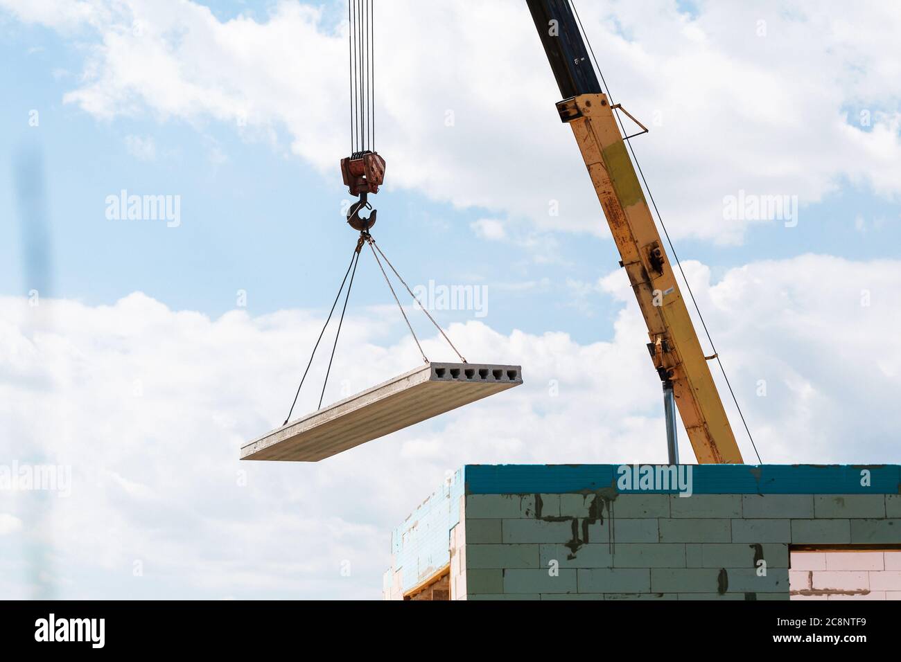 Builder worker installing concrete floor slab panel at building ...