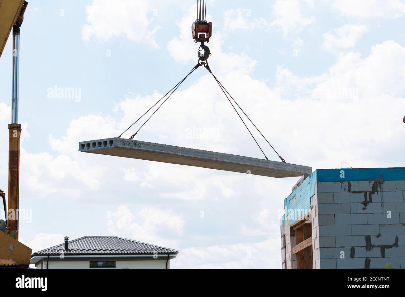 Builder worker installing concrete floor slab panel at building ...