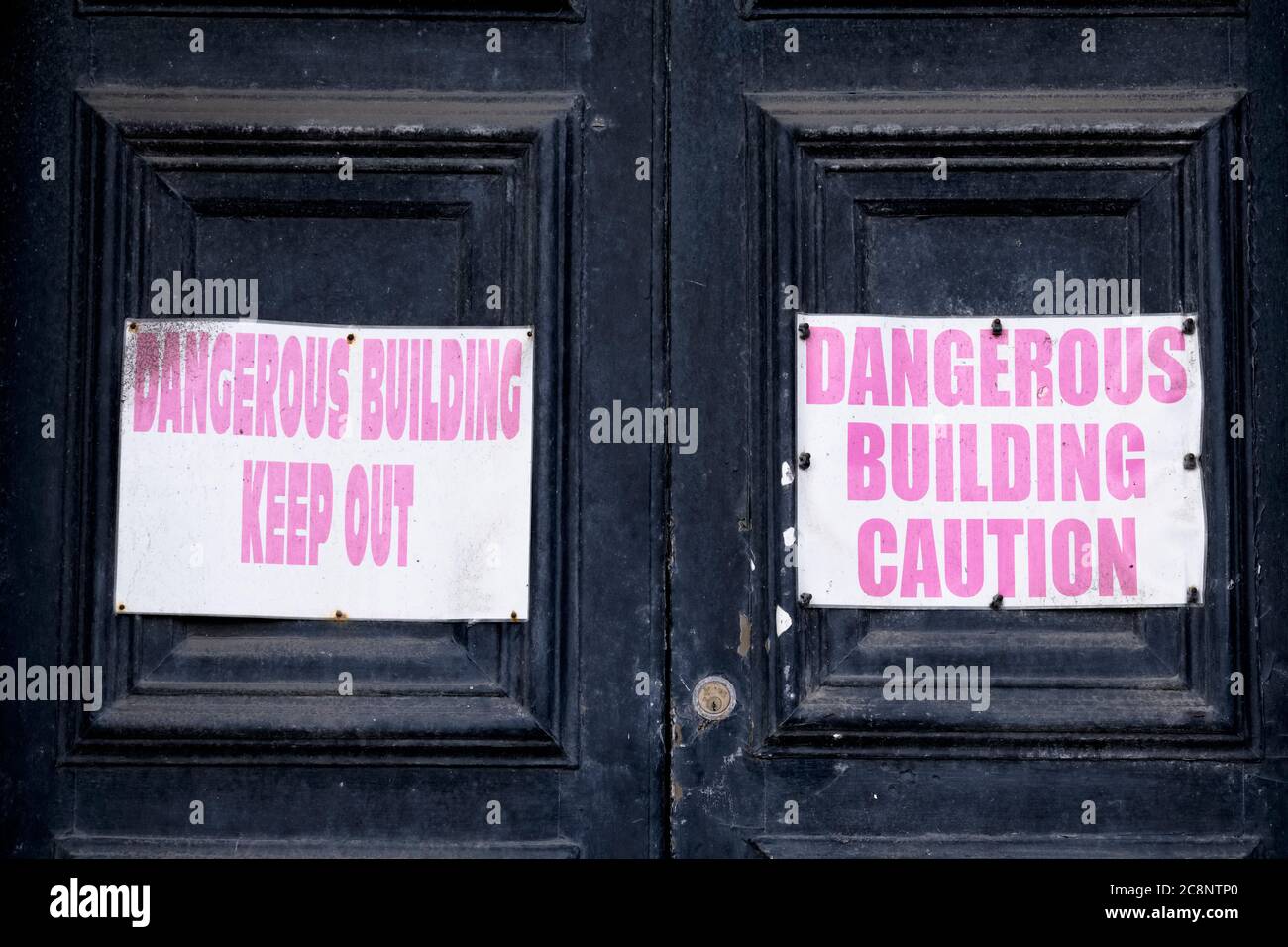 Unstable building keep out dangerous sign on fence at building ...