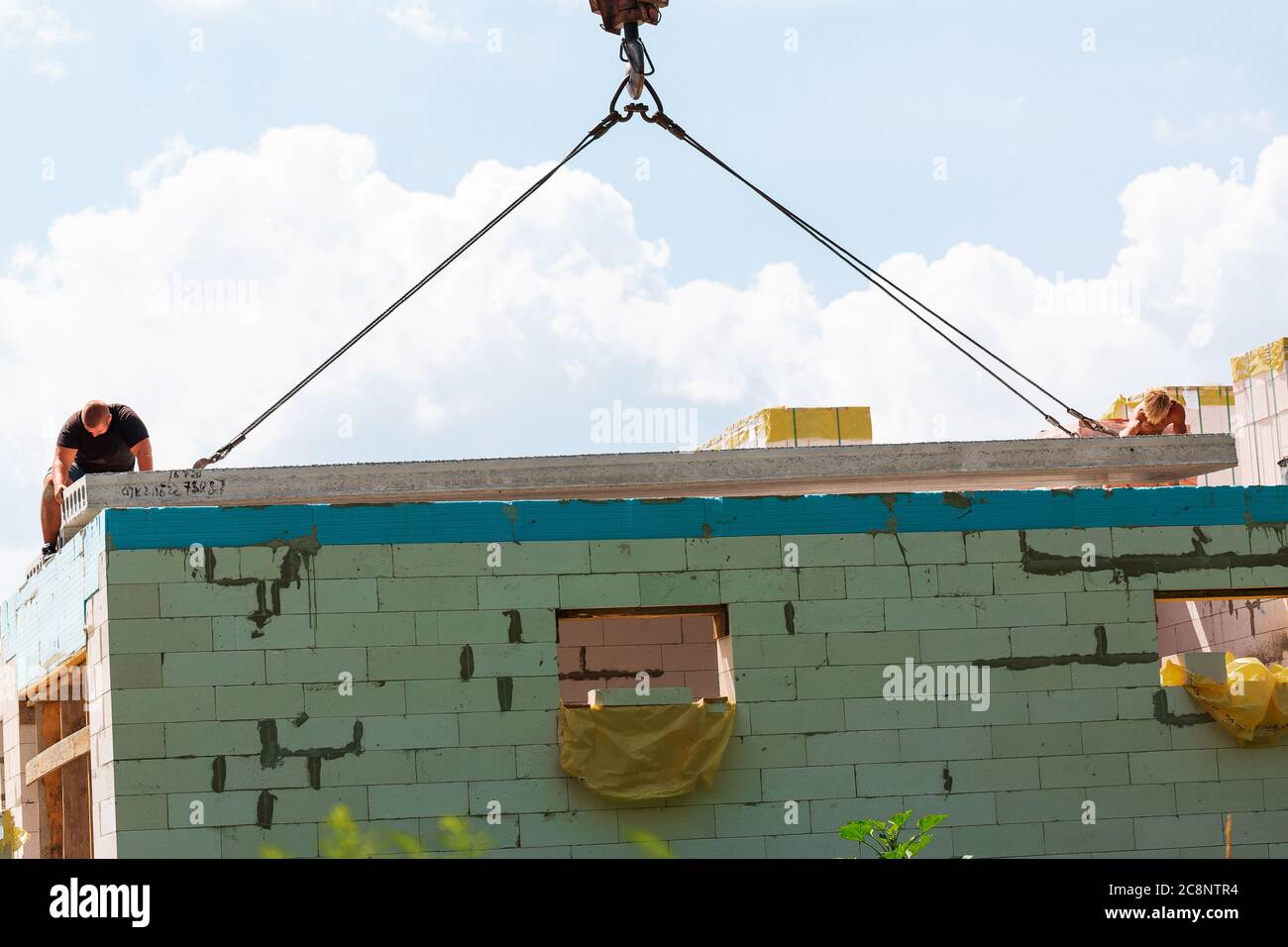 Builder worker installing concrete floor slab panel at building ...