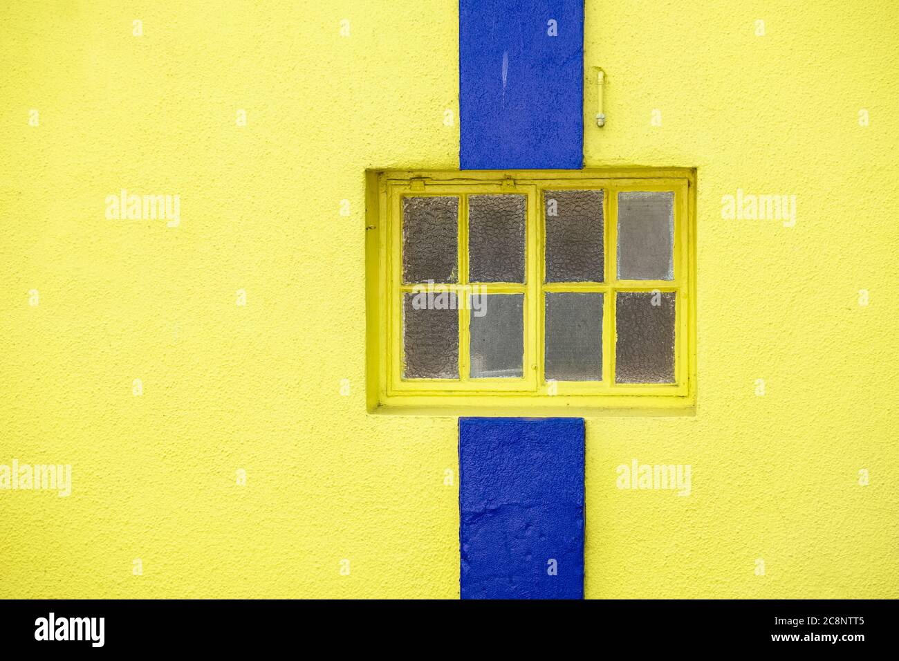 Yellow and blue strip wall and window close up Stock Photo - Alamy