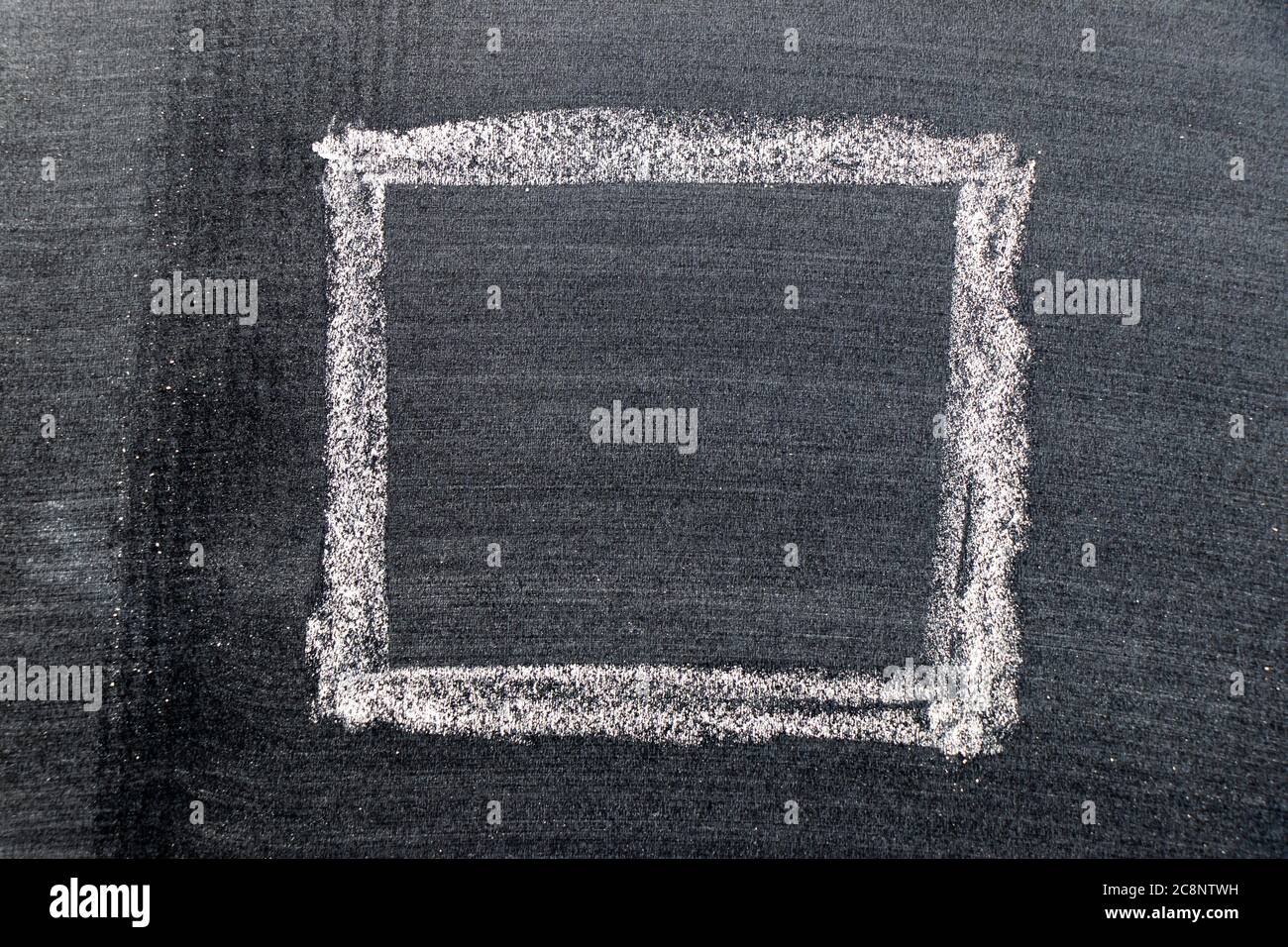 White color chalk hand drawing in square shape on black board ...