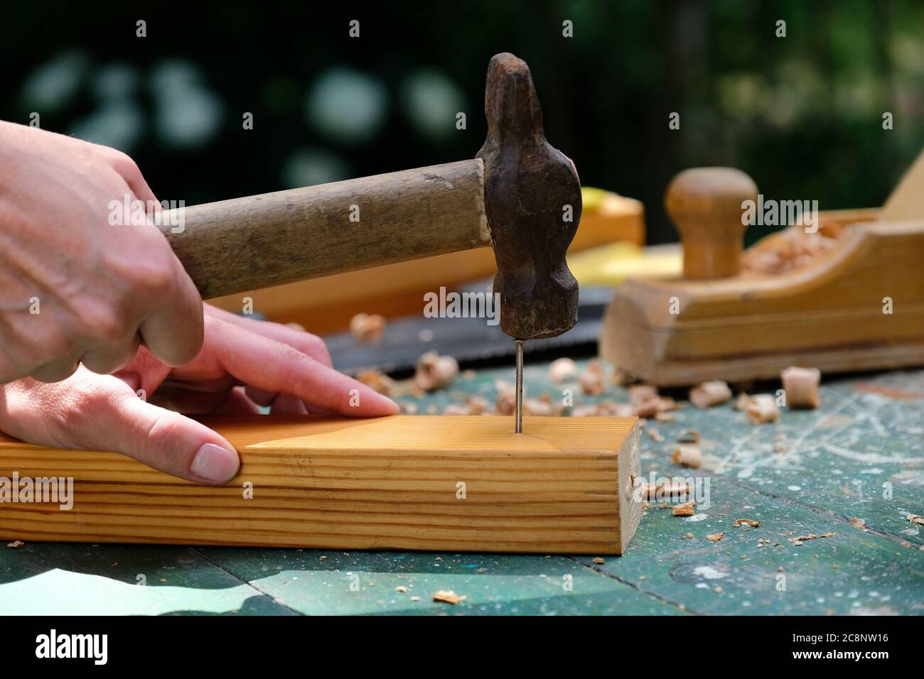 Woman hammering a nail hi-res stock photography and images - Alamy