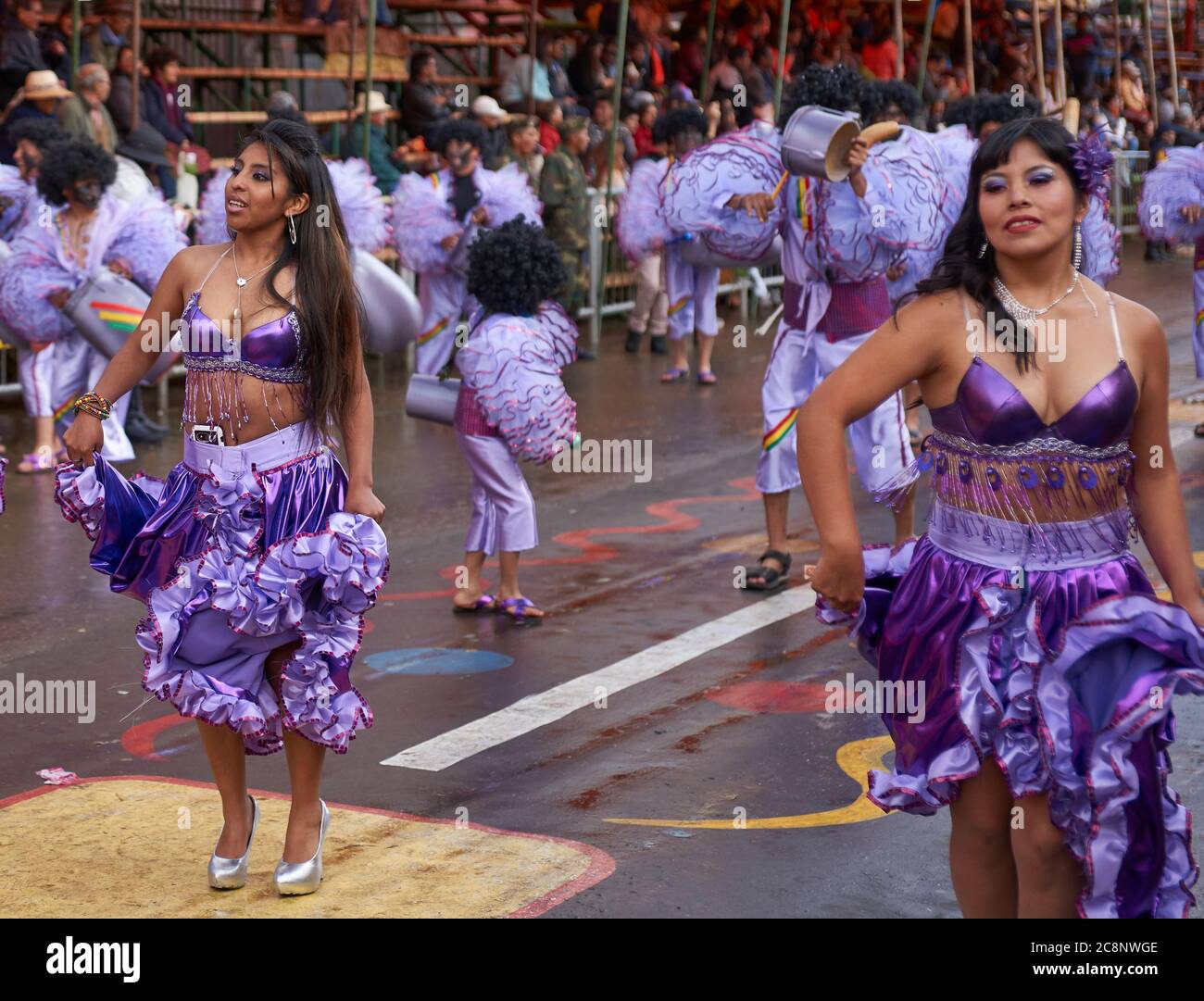 Female dancers in colourful costumes parade through the mining city of ...