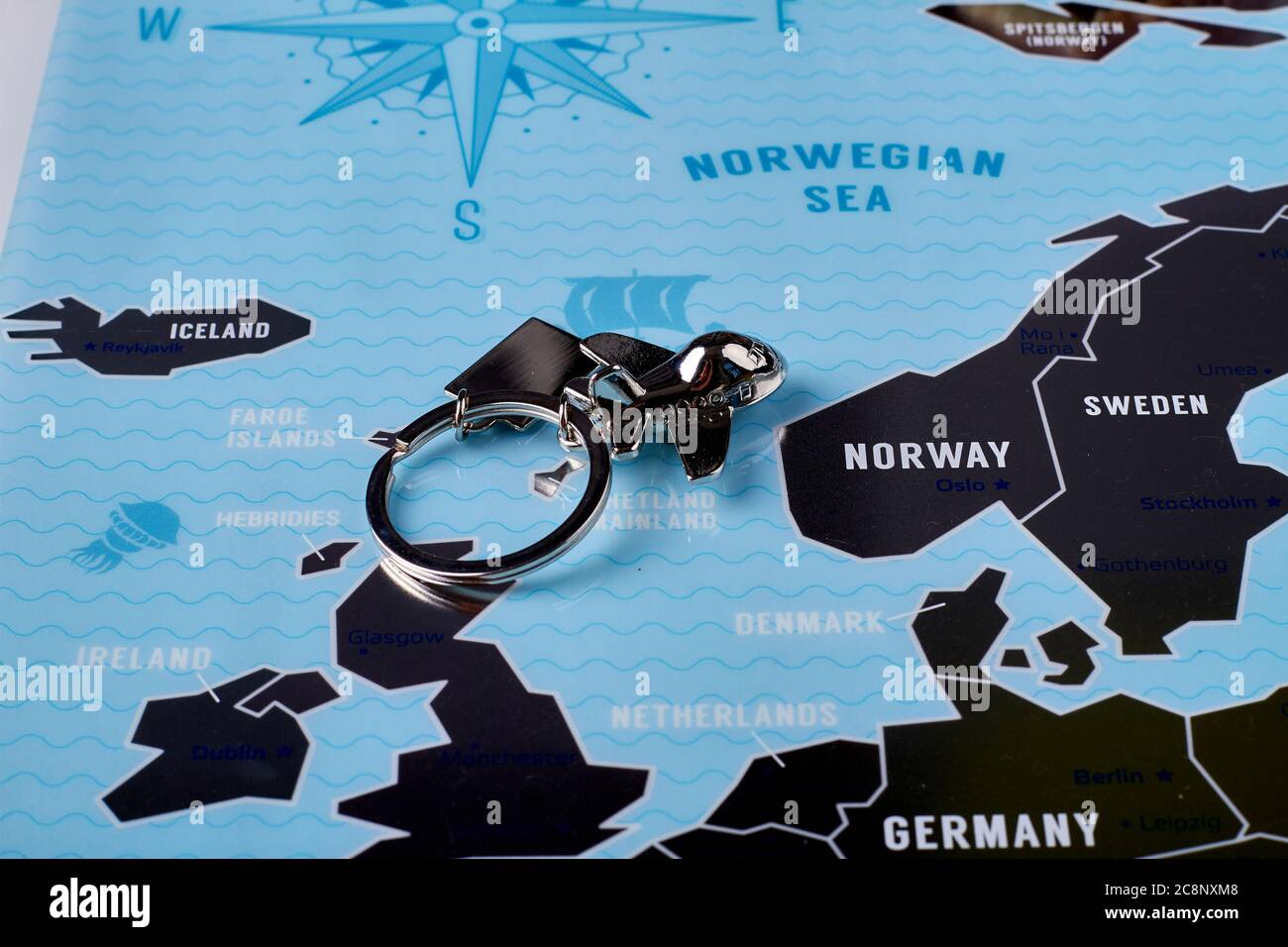 Metal charm in a shape of a plane on a map of europe Stock Photo - Alamy