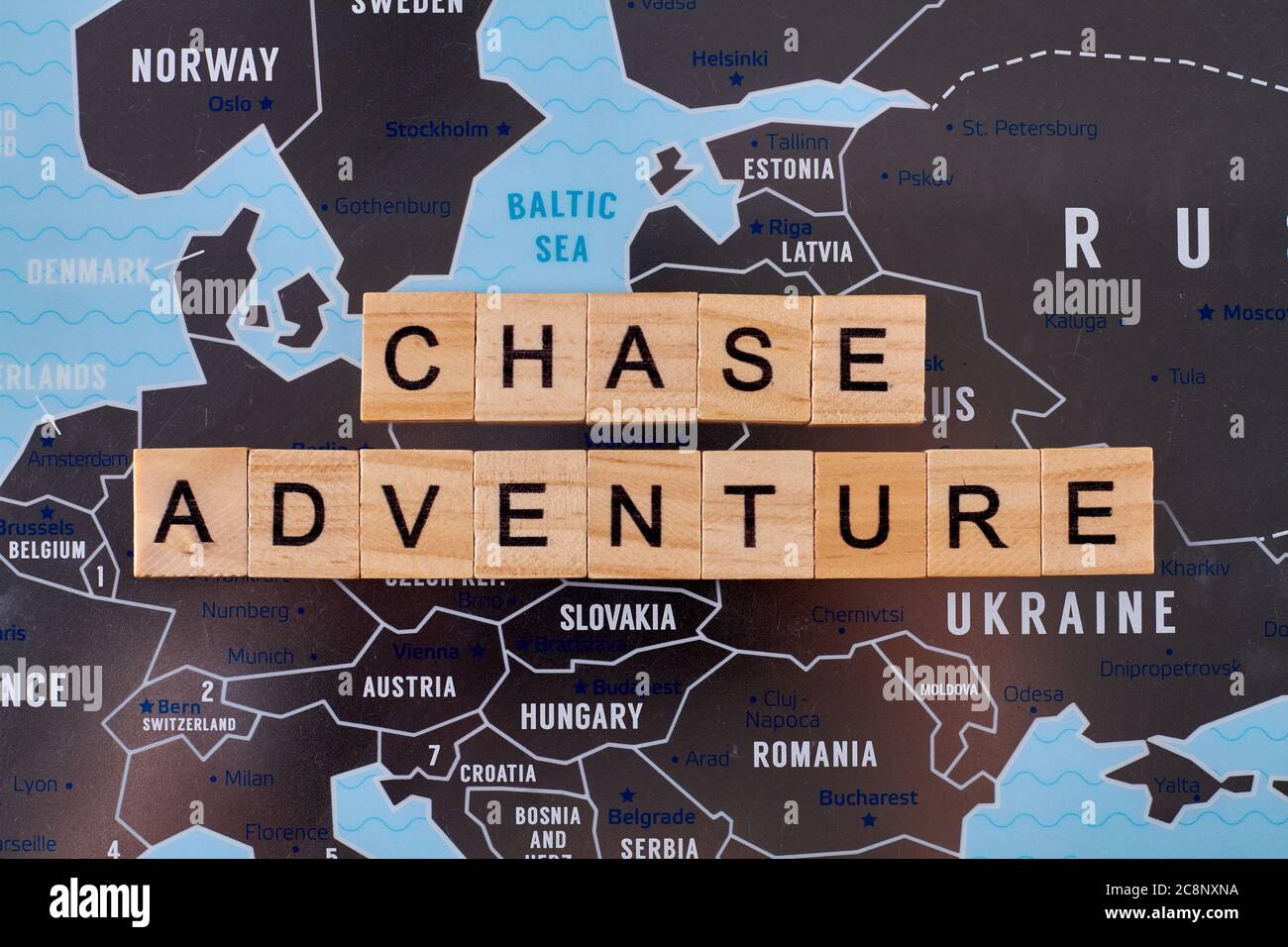 Chase adventure slogan on a map Stock Photo - Alamy