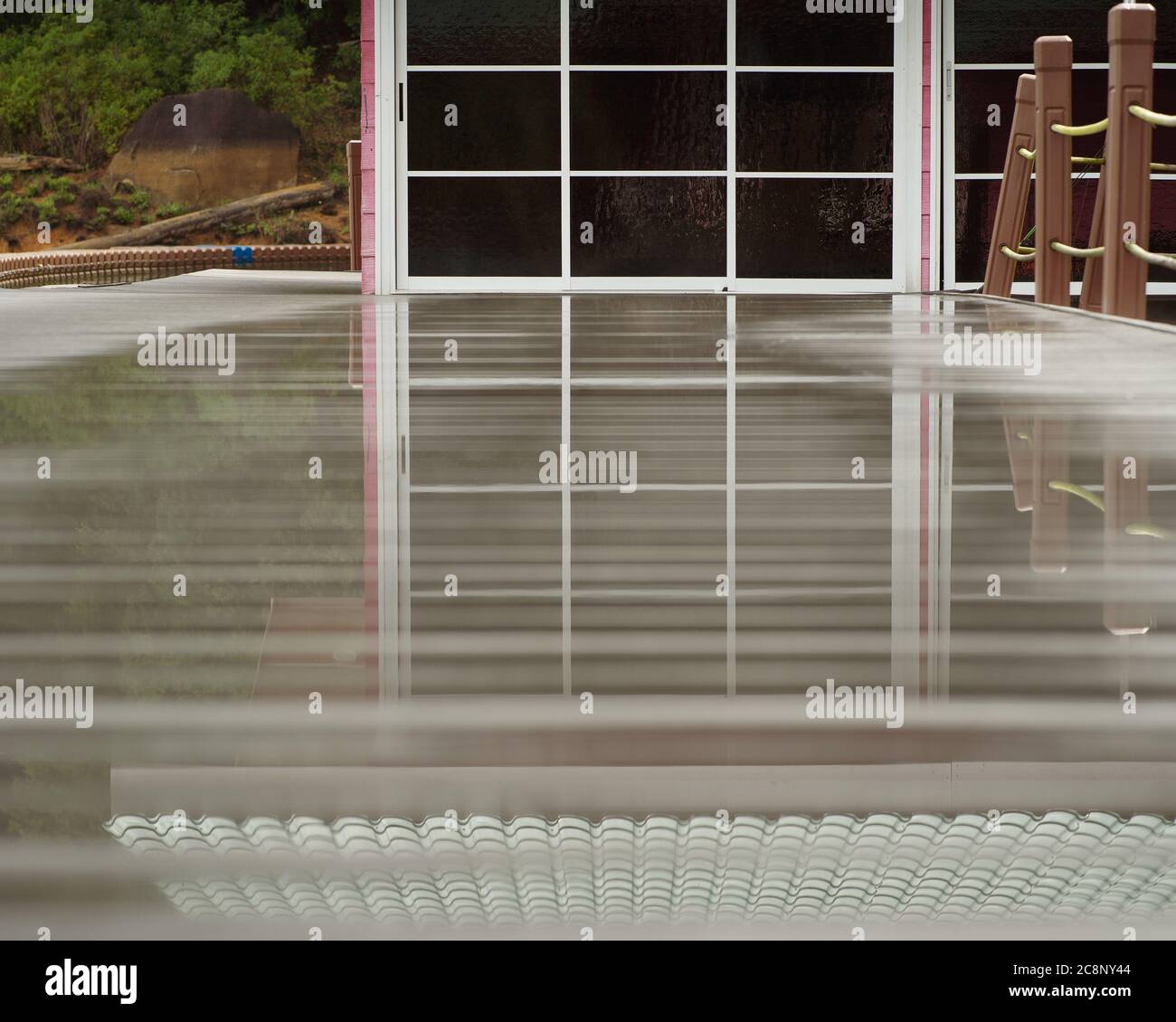 Reflections on rain puddle on the floor in a floating resort. Concept ...