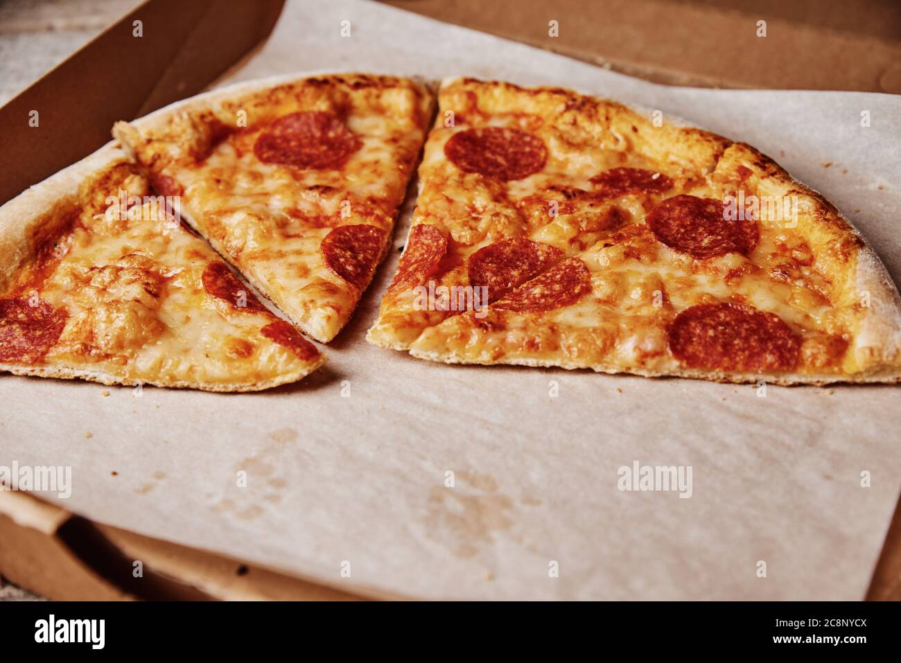 Slice of pizza in cardboard box, close up Stock Photo - Alamy
